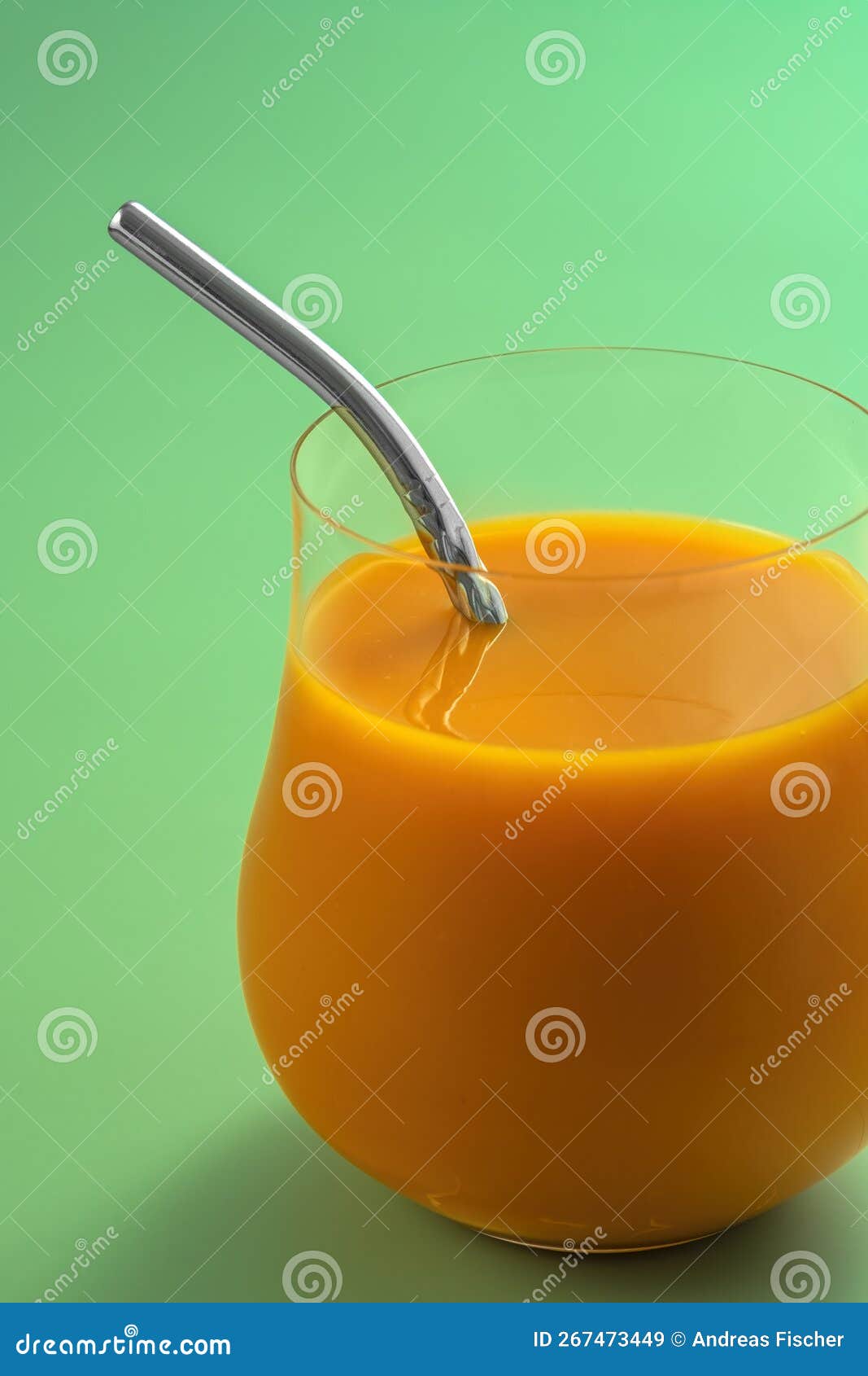 Orange Juice in a Glass with a Straw on a Green Background. Stock Image ...