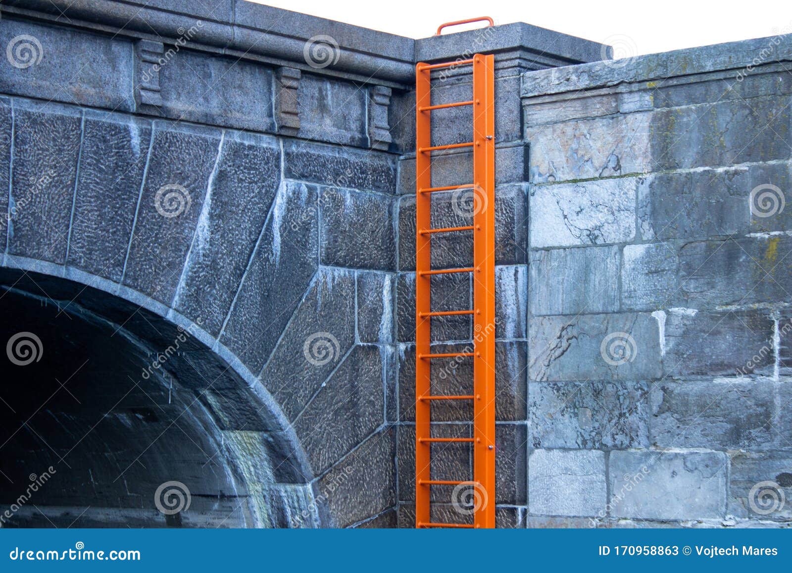An Orange Ladder Fixed in a Water Canal at the Arched Stone Bridge in ...