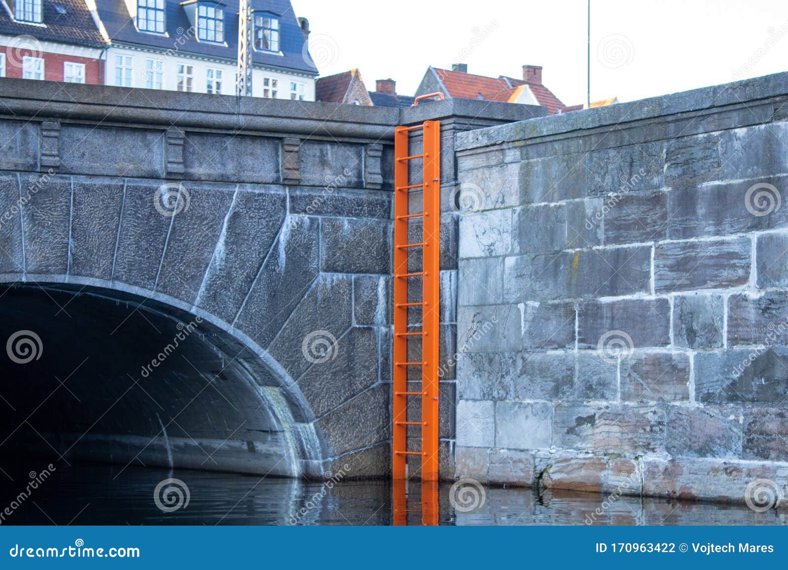 An Orange Ladder Fixed in a Water Canal at the Arched Stone Bridge in ...