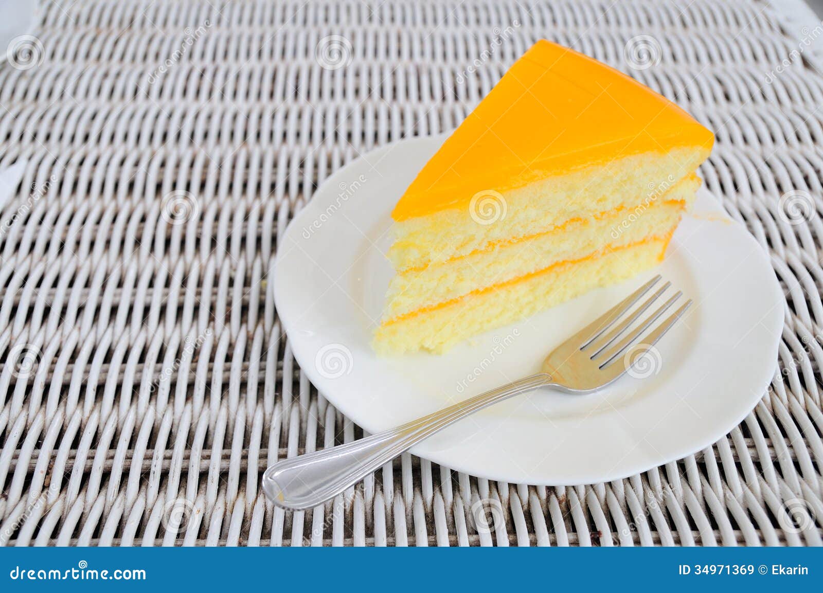 Orange Layer Cake on White Plate Put on Rattan Table. Stock Image ...