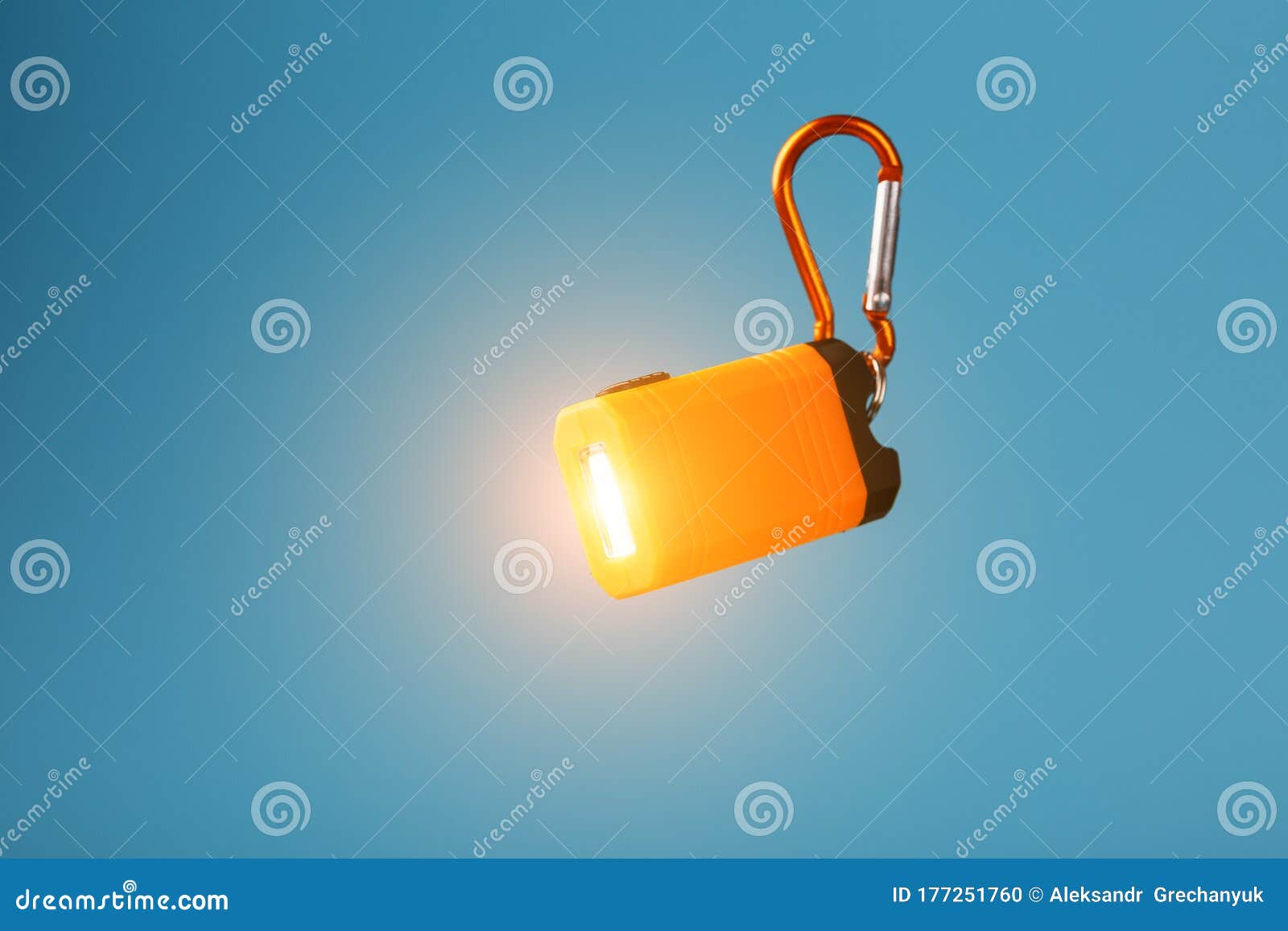 Orange Led Flashlight with a Carabiner on a Blue Background. LED Lights ...