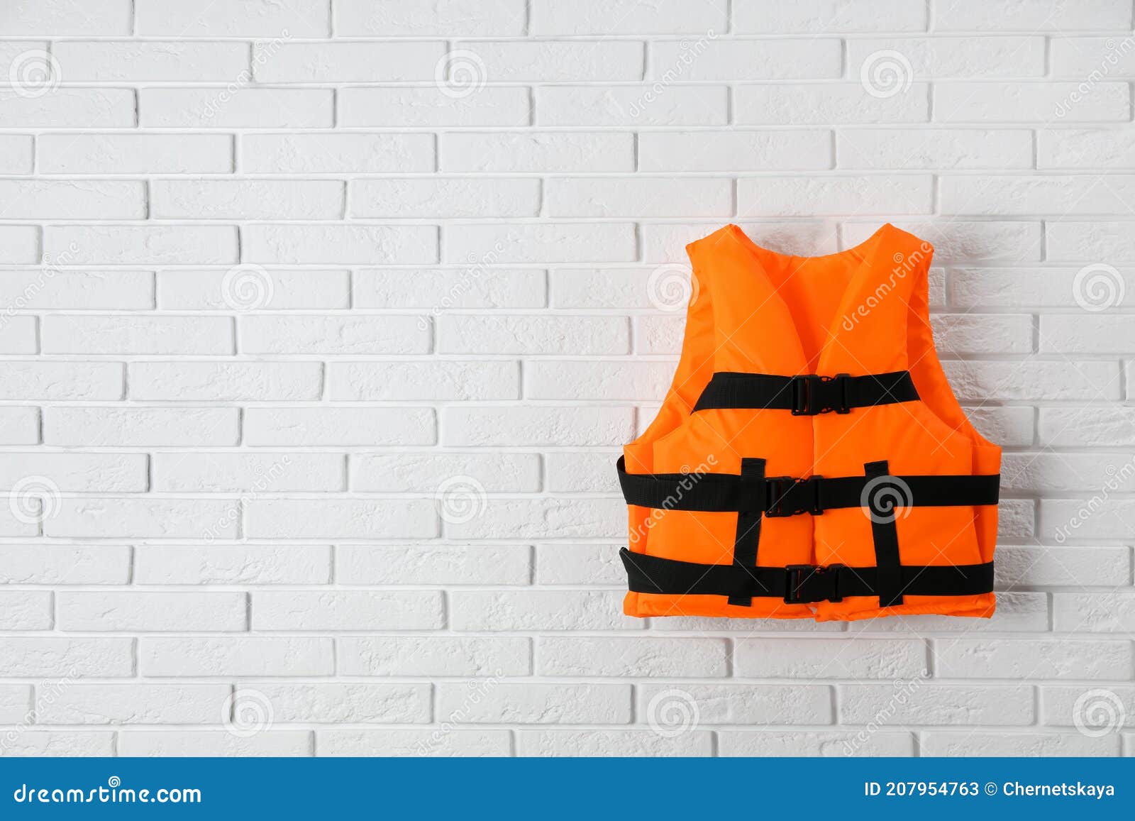Orange Life Jacket on White Brick Wall. Space for Text Stock Image ...