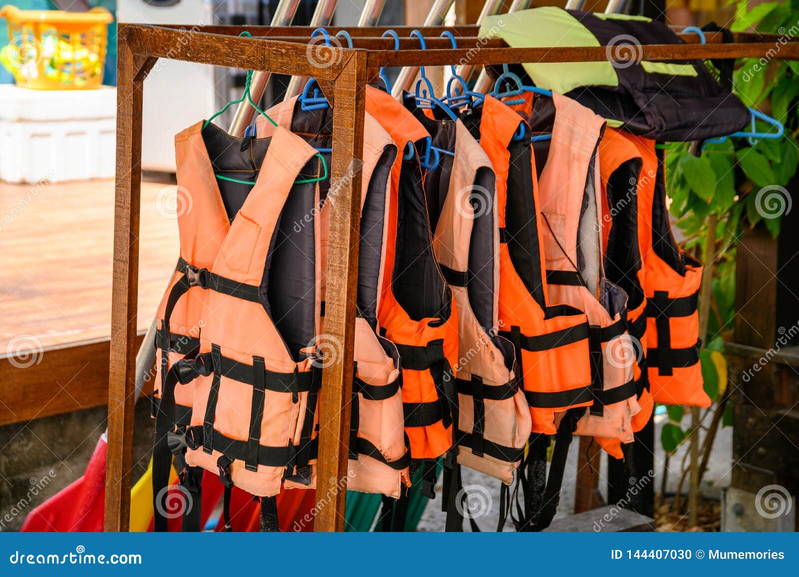 Orange Life Jackets Hanging on Rack Stock Photo - Image of orange ...