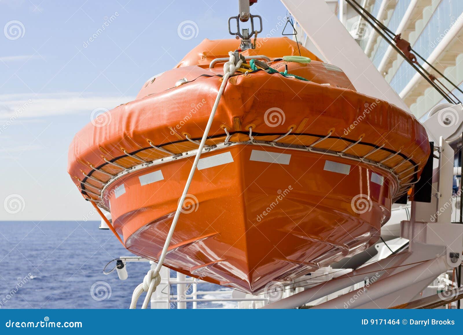 Orange Life Raft on Hoist stock photo. Image of safety - 9171464