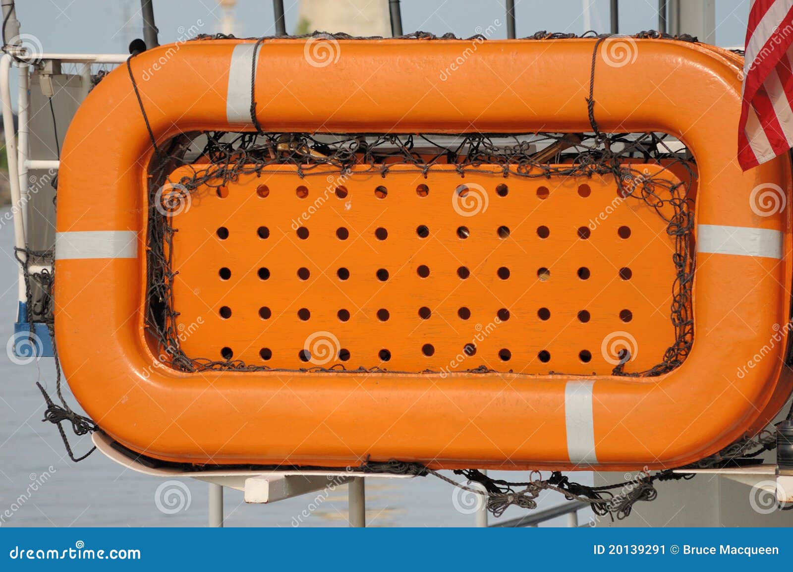 Orange Lifeboat At Tail Of International Cargo Ship In The Ocean For ...