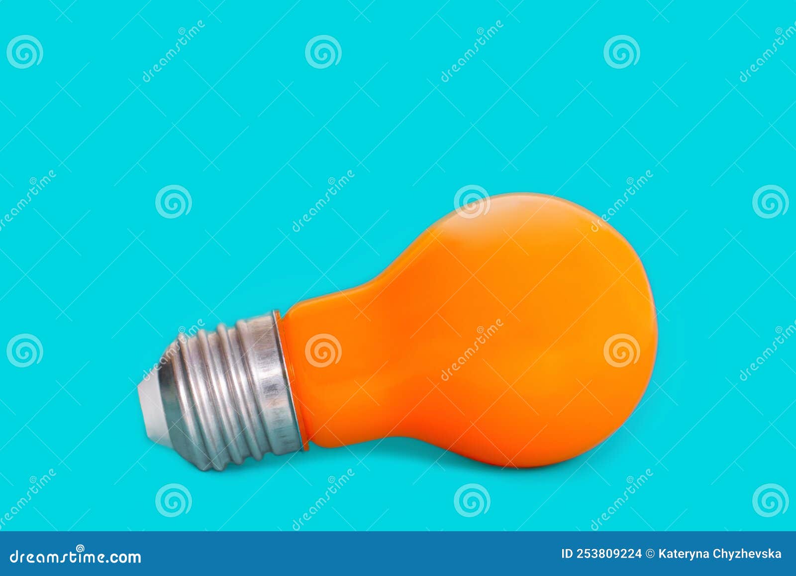 Orange Light Bulb Isolated on Blue Background Stock Photo - Image of ...