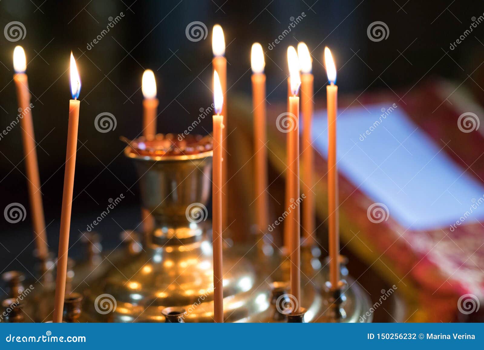 Orange Lit Candles Stand in a Candlestick Stock Photo - Image of ...