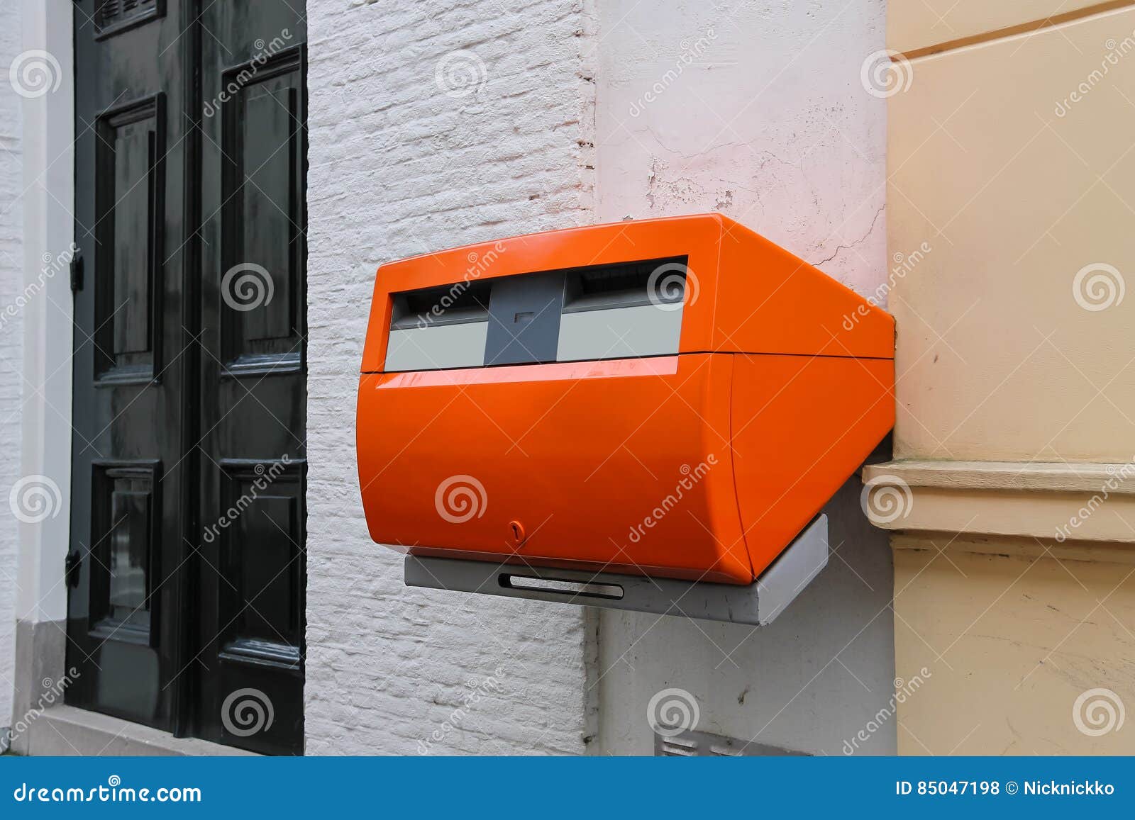 Orange mailbox on the wall stock photo. Image of house - 85047198