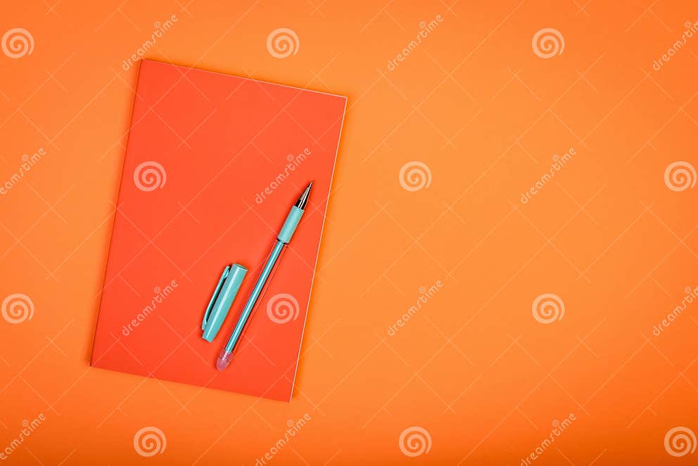 Orange Notebook and Pen on Orange Background. Stock Image - Image of ...