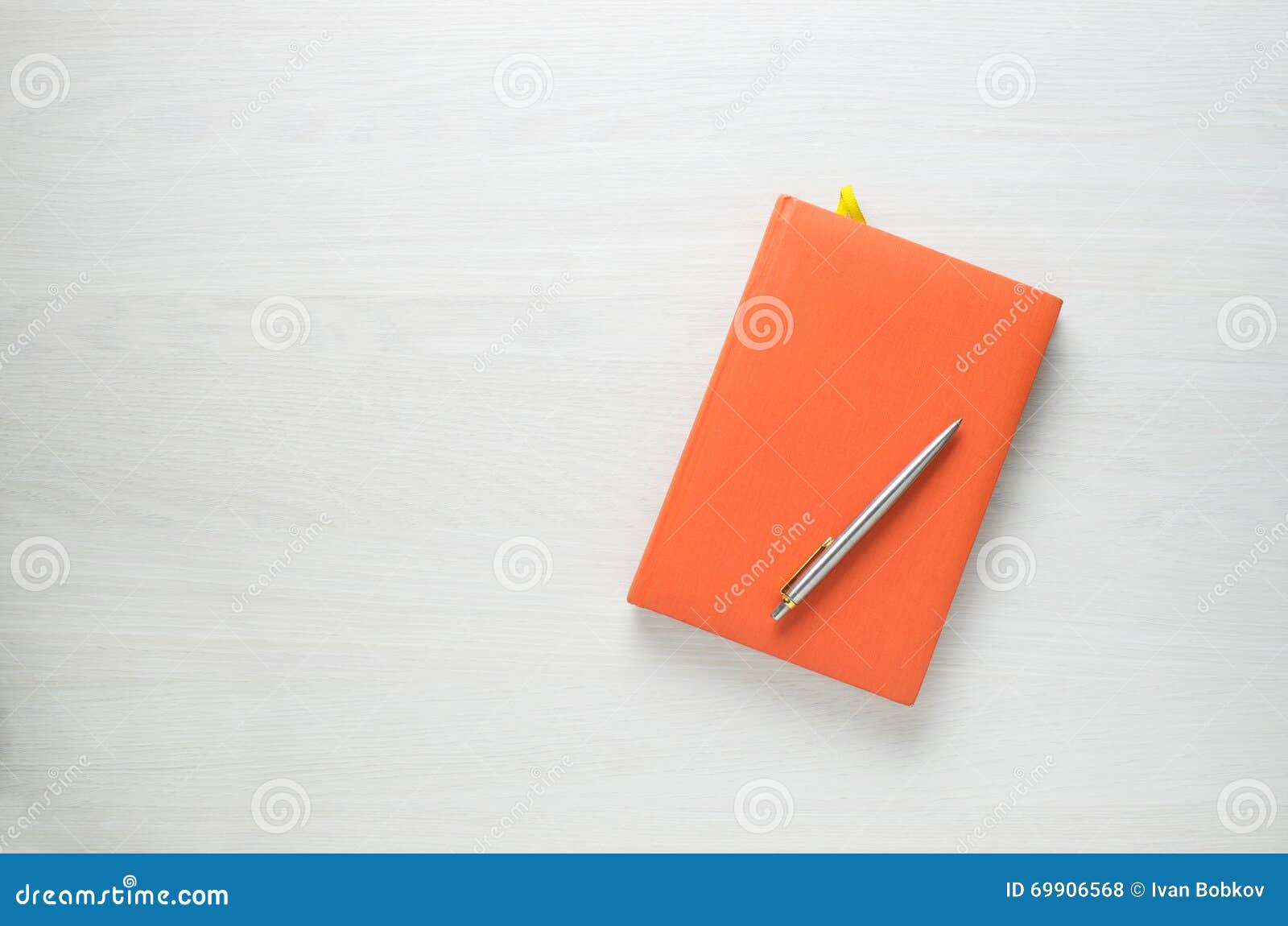 Orange Notepad with a Pen on White Wooden Background Stock Photo ...