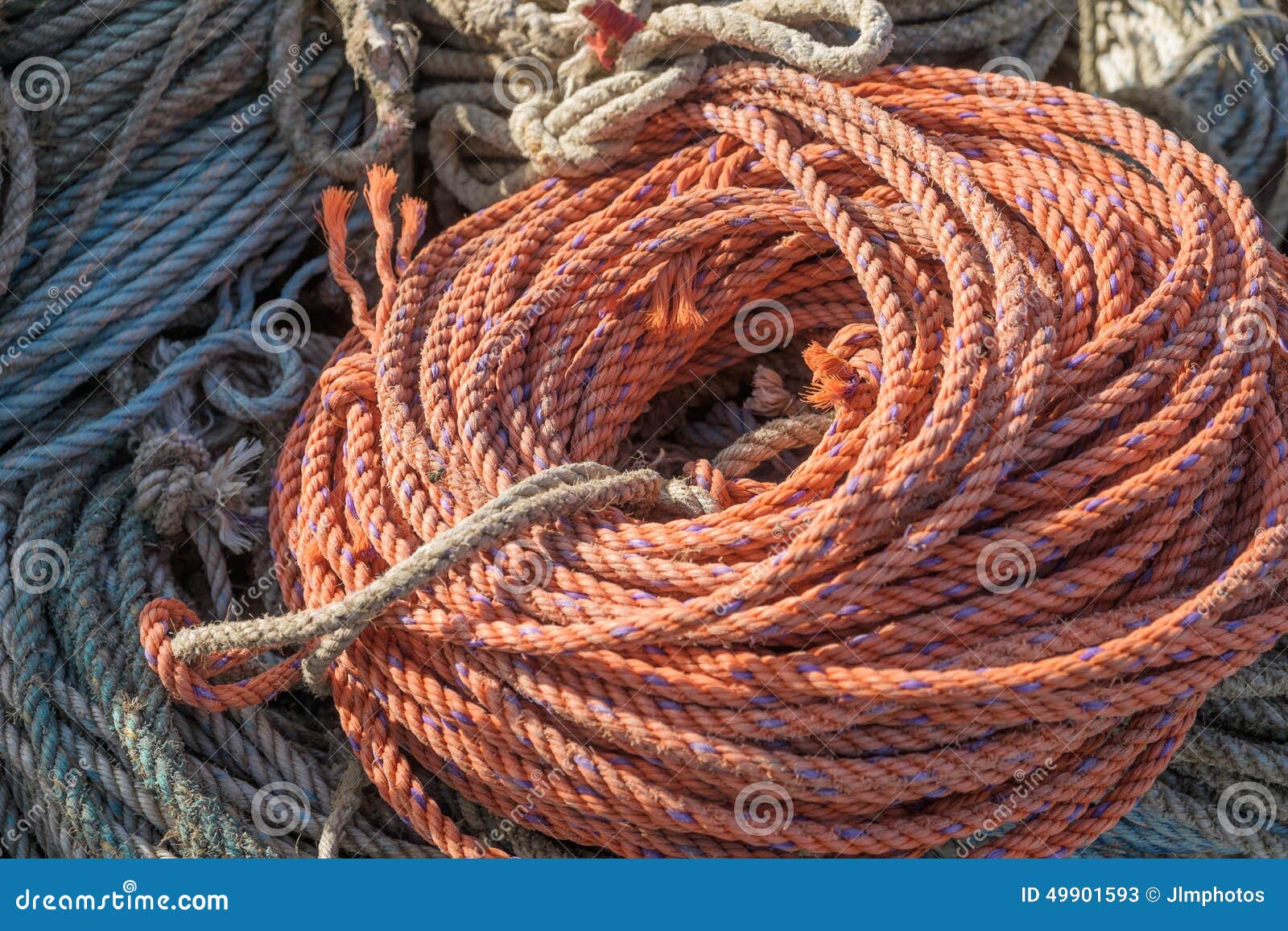Orange Nylon Rope Coiled and Ready for Use on a Working Dock Stock ...
