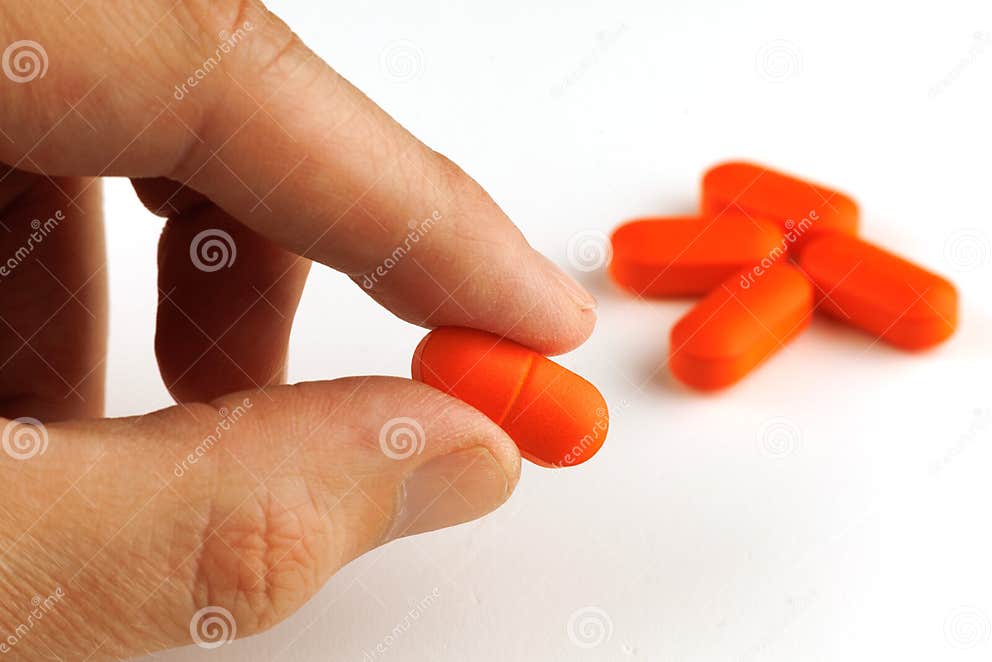 Orange Oblong Tablet in Hand Stock Image - Image of round, object ...
