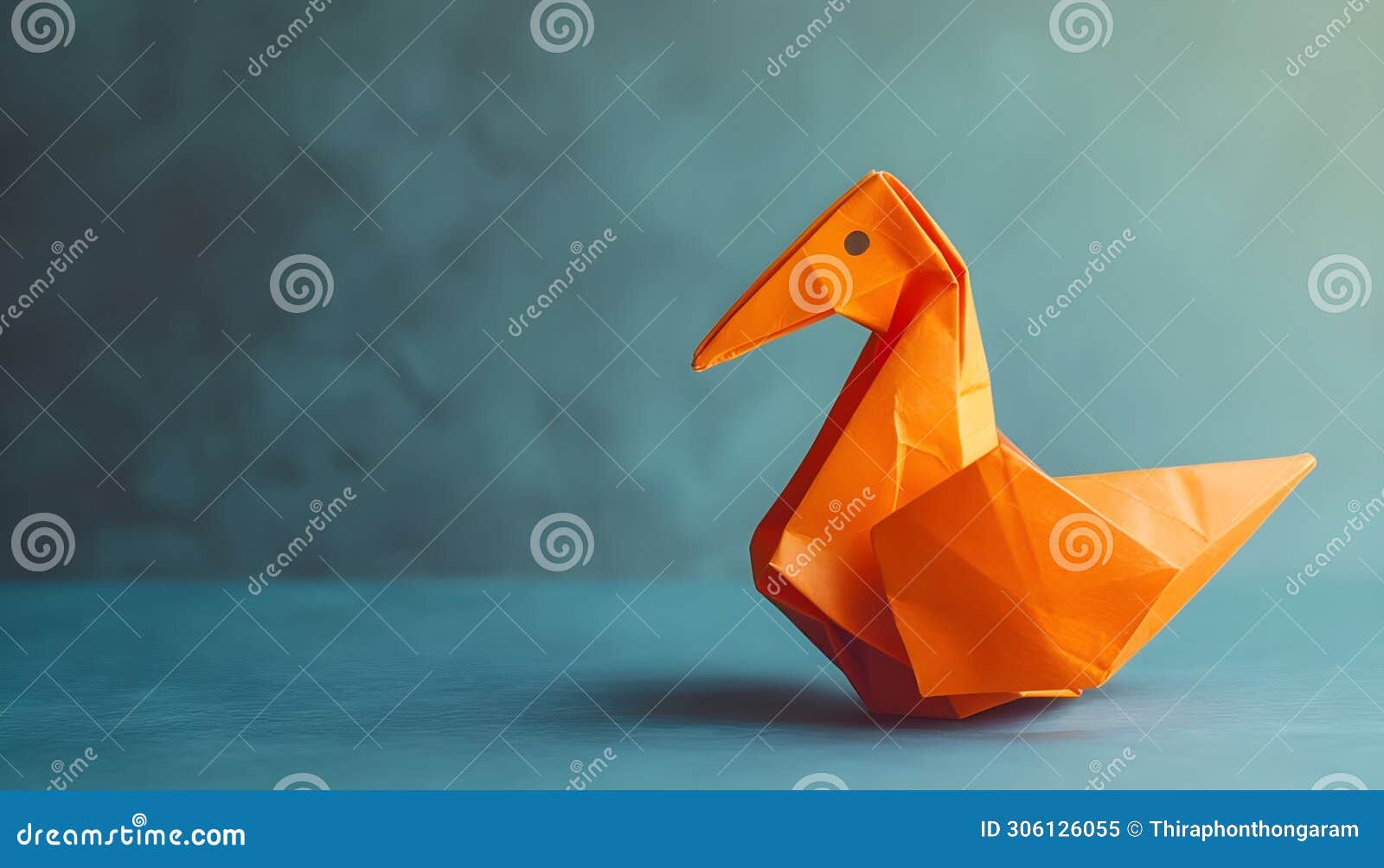 Orange Origami Duck on a Plain Blue Colored Background Stock ...