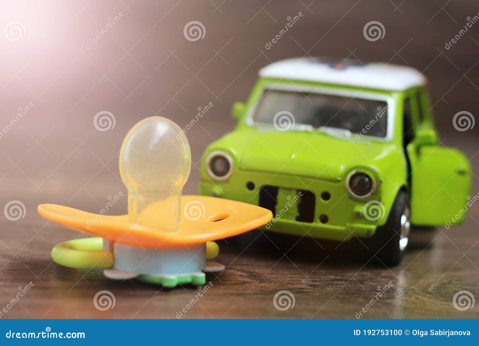 Orange Orthodontic Pacifier and a Car Toy Stock Photo - Image of rubber ...