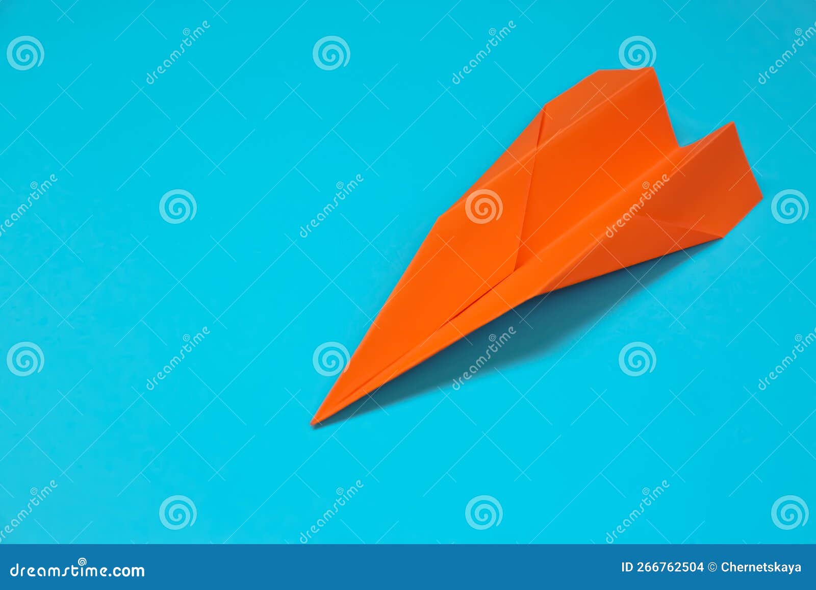 Orange Paper Plane on Light Blue Background, Space for Text Stock Photo ...