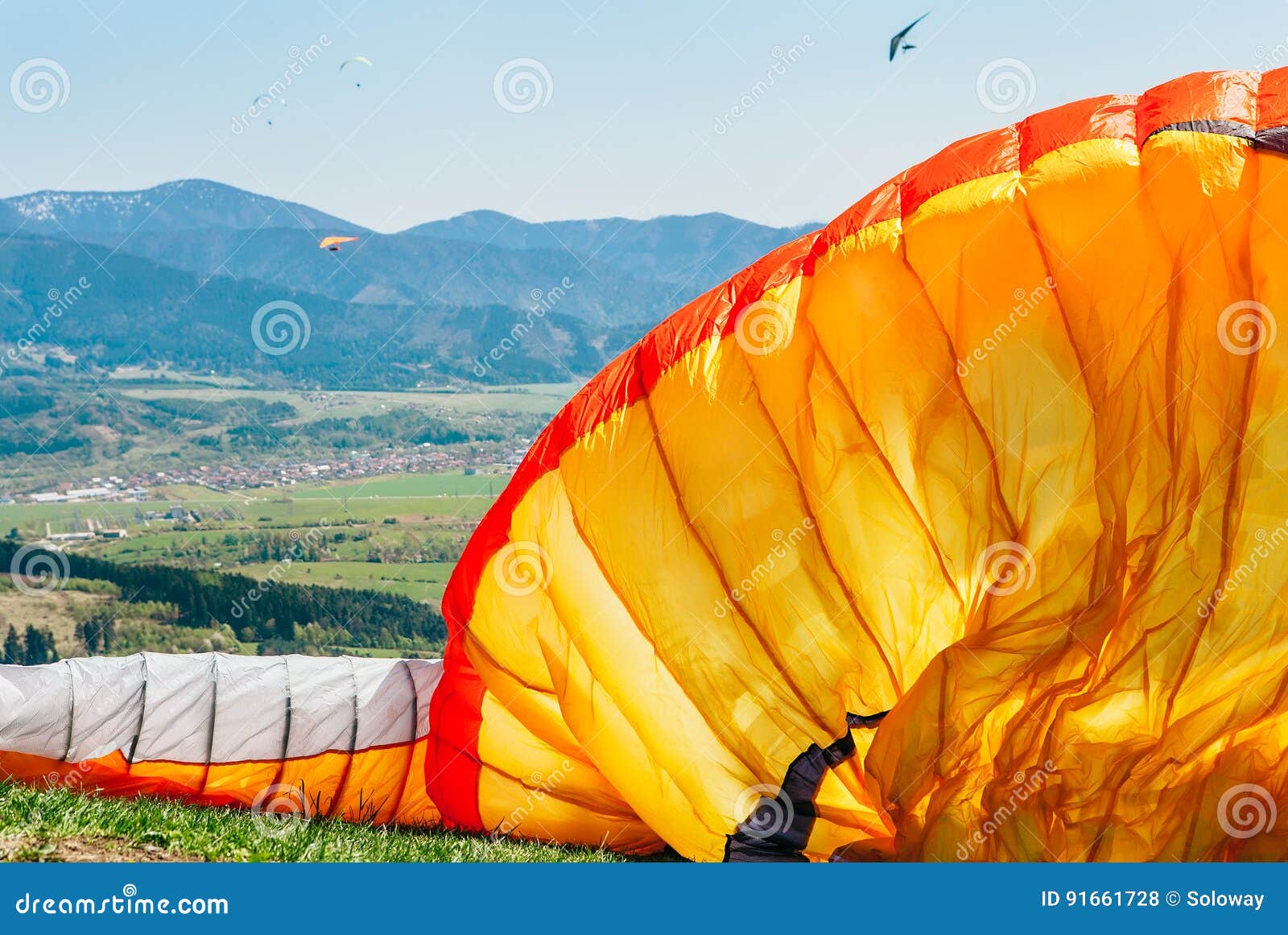 Orange Parachute Lying on the Ground Stock Photo - Image of adrenalin ...