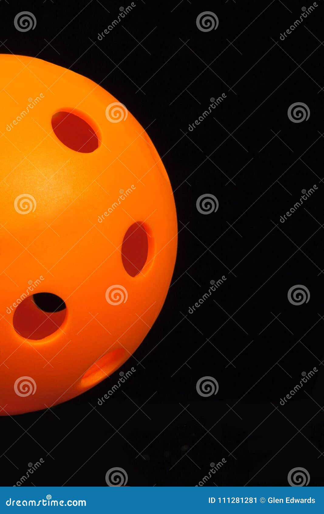 Orange Pickleball Emerging from Left on Black Background. Stock Image ...