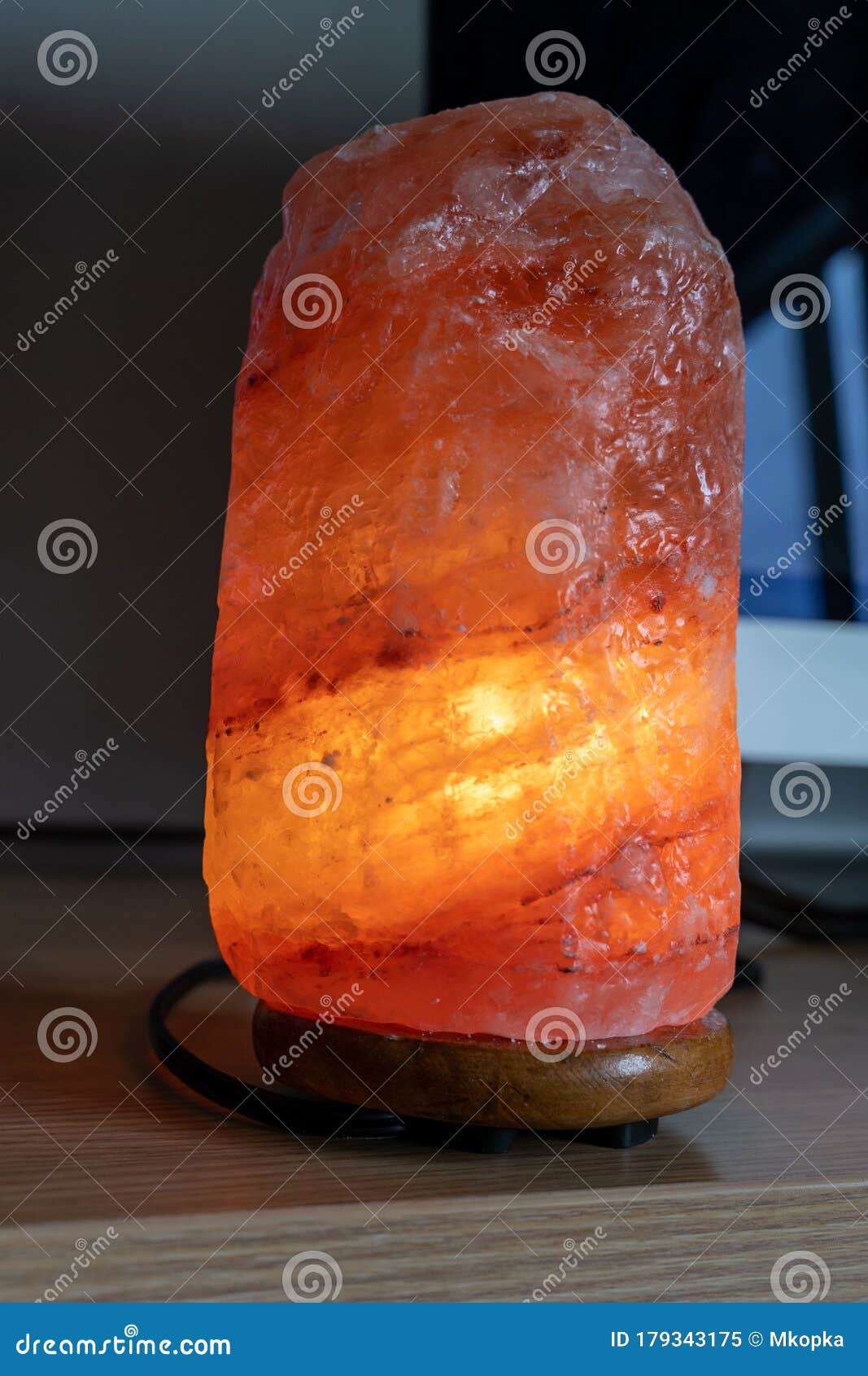 An Orange Pink Glowing Himalayan Salt Lamp Sits on a Computer Desk ...