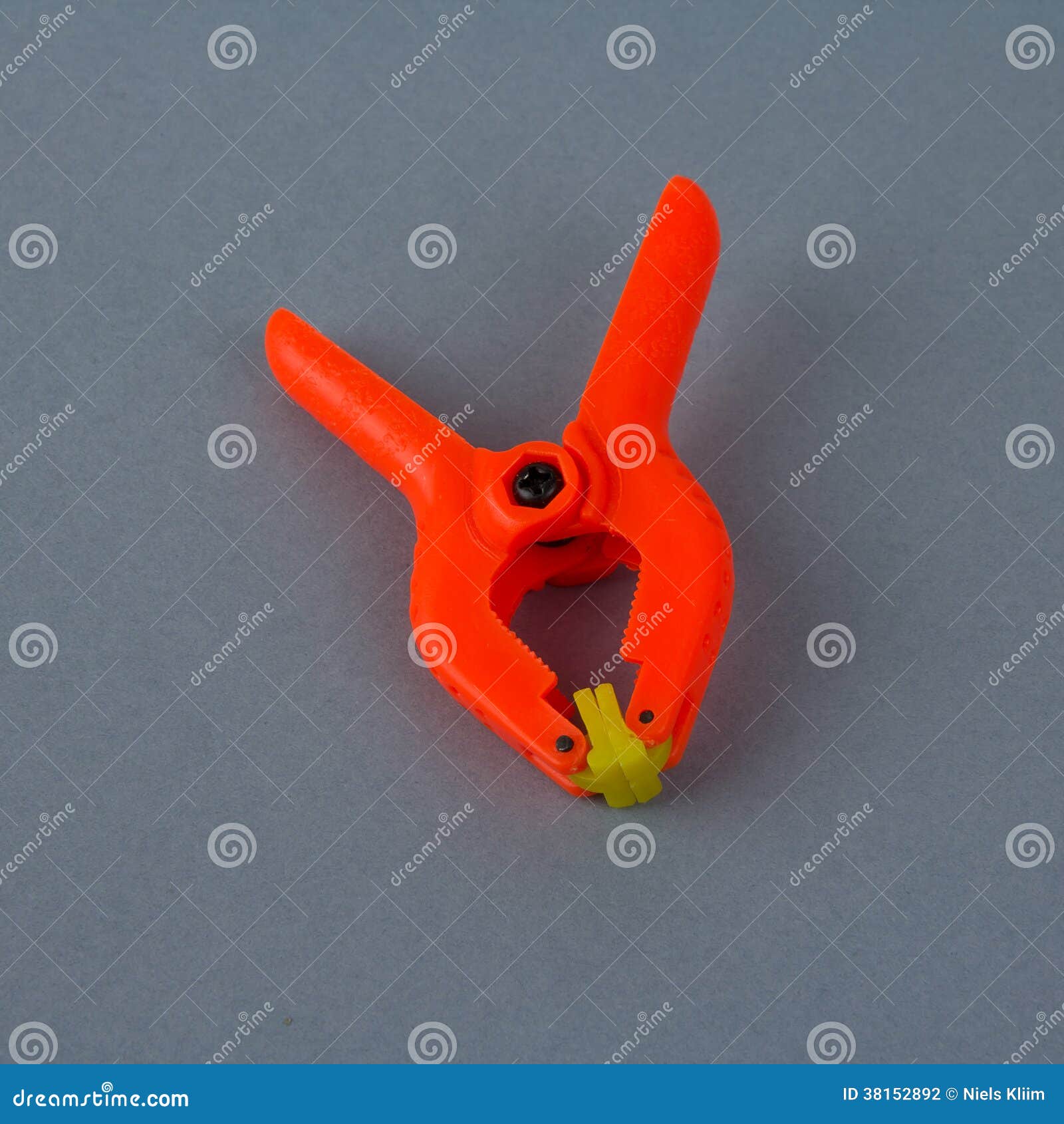 Orange plastic clamp stock photo. Image of orange, hand - 38152892