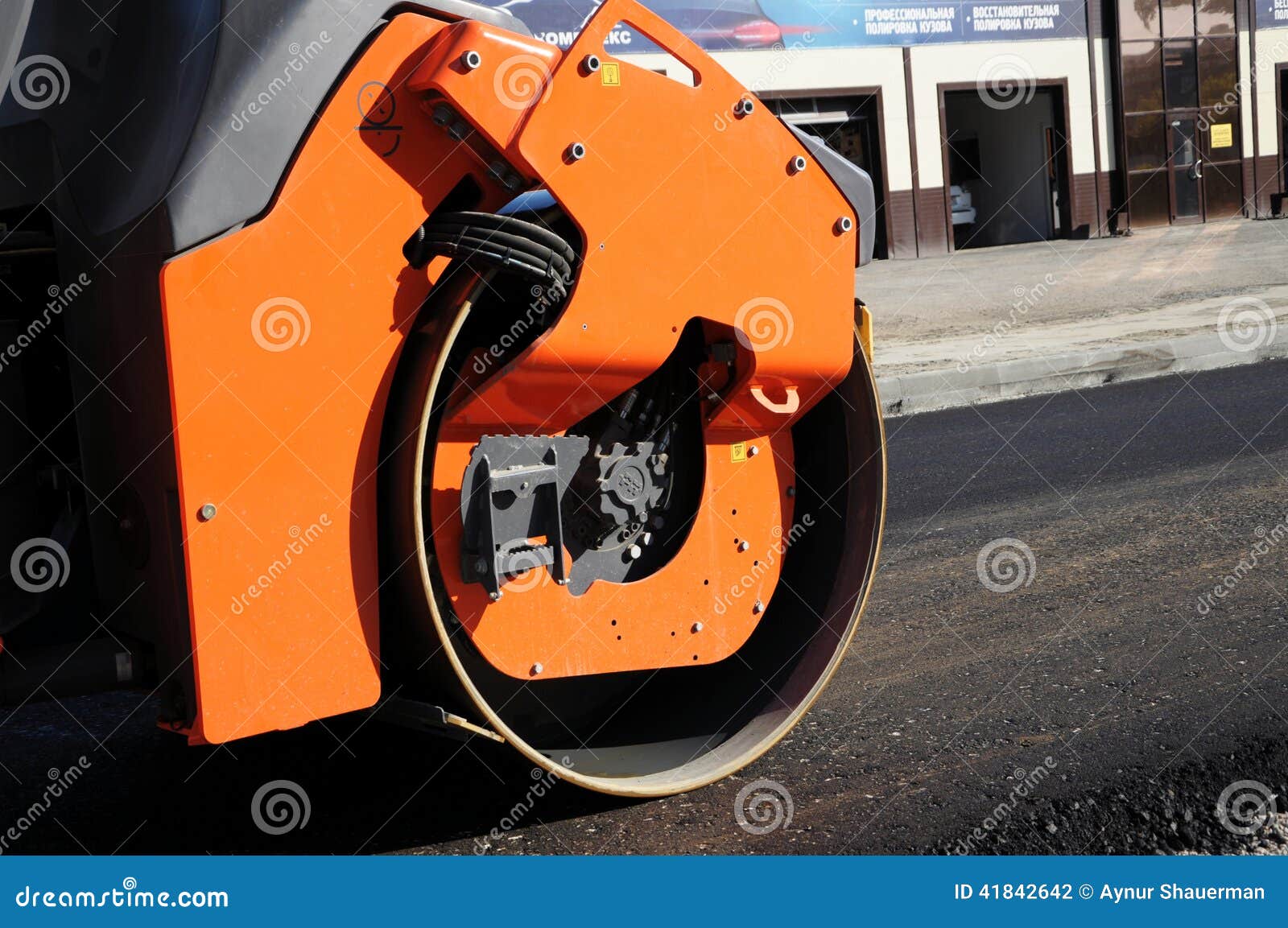 Orange Rolling Machinery Wheel Stock Photo - Image of road, activity ...