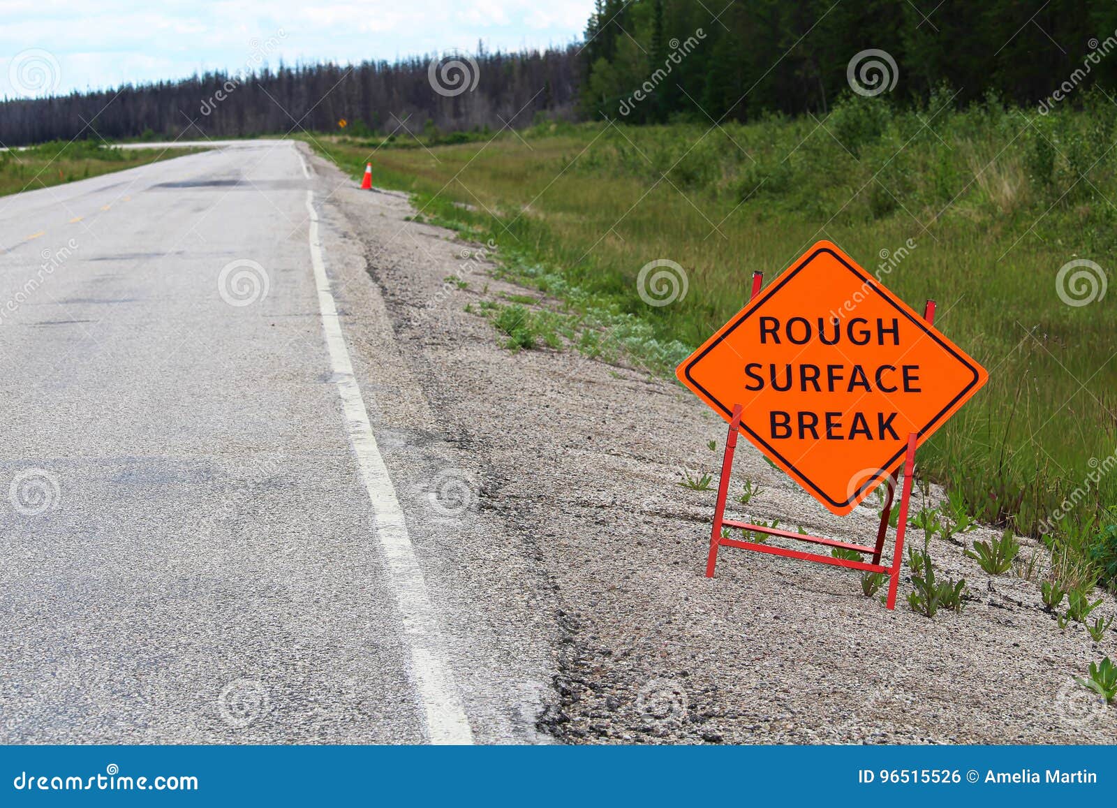 An Orange Rough Surface Break Sign with a Road into the Distance Stock ...