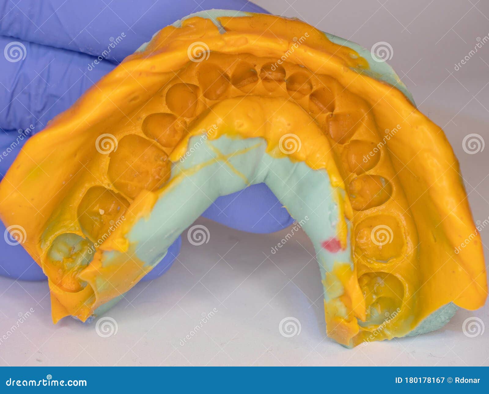 Orange Silicon Teeth Imprint in Dentist Hand Stock Image - Image of ...
