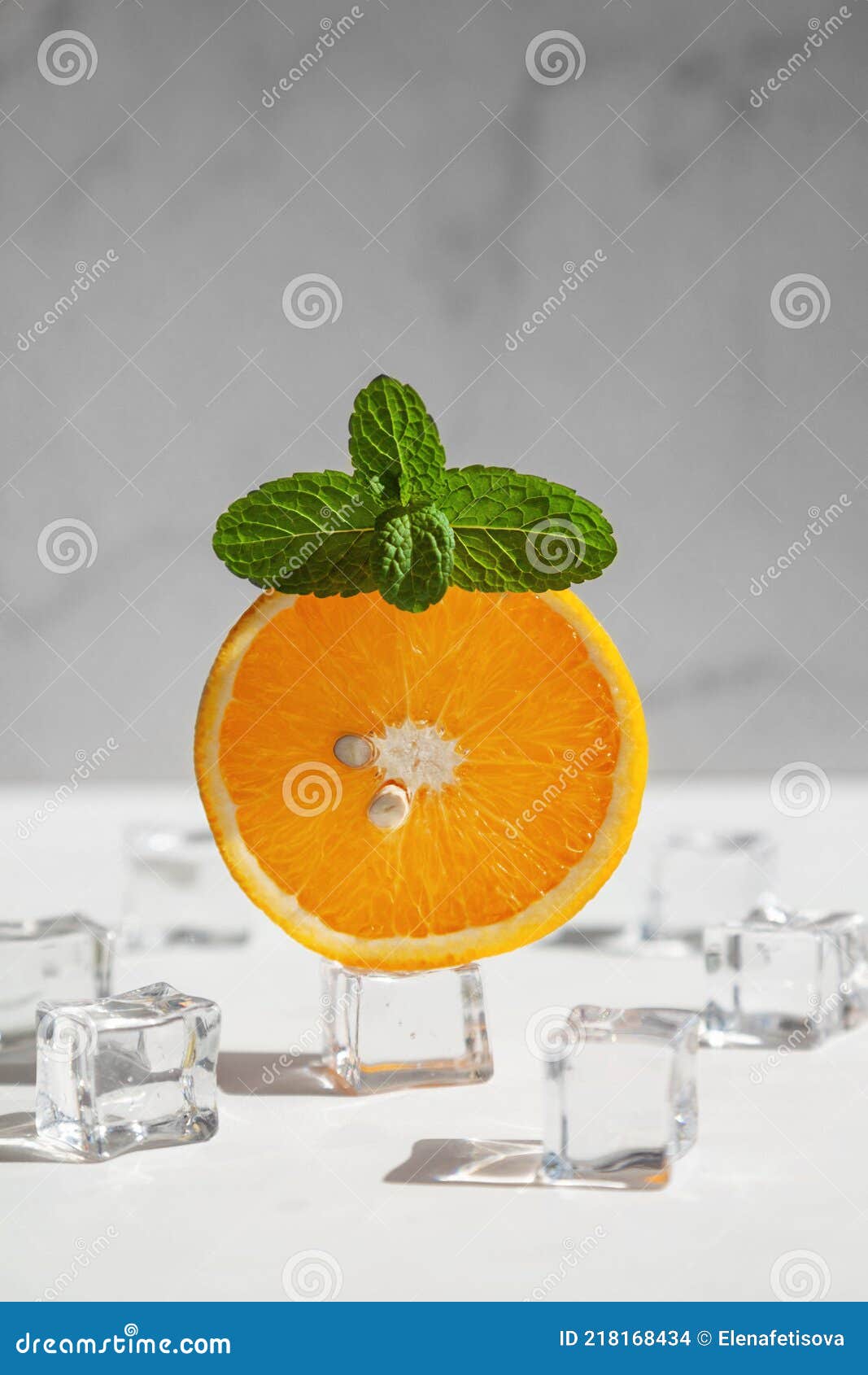 Orange Slice with Leaf of Mint on Cube of Ice. Citrus Ship on Ice ...