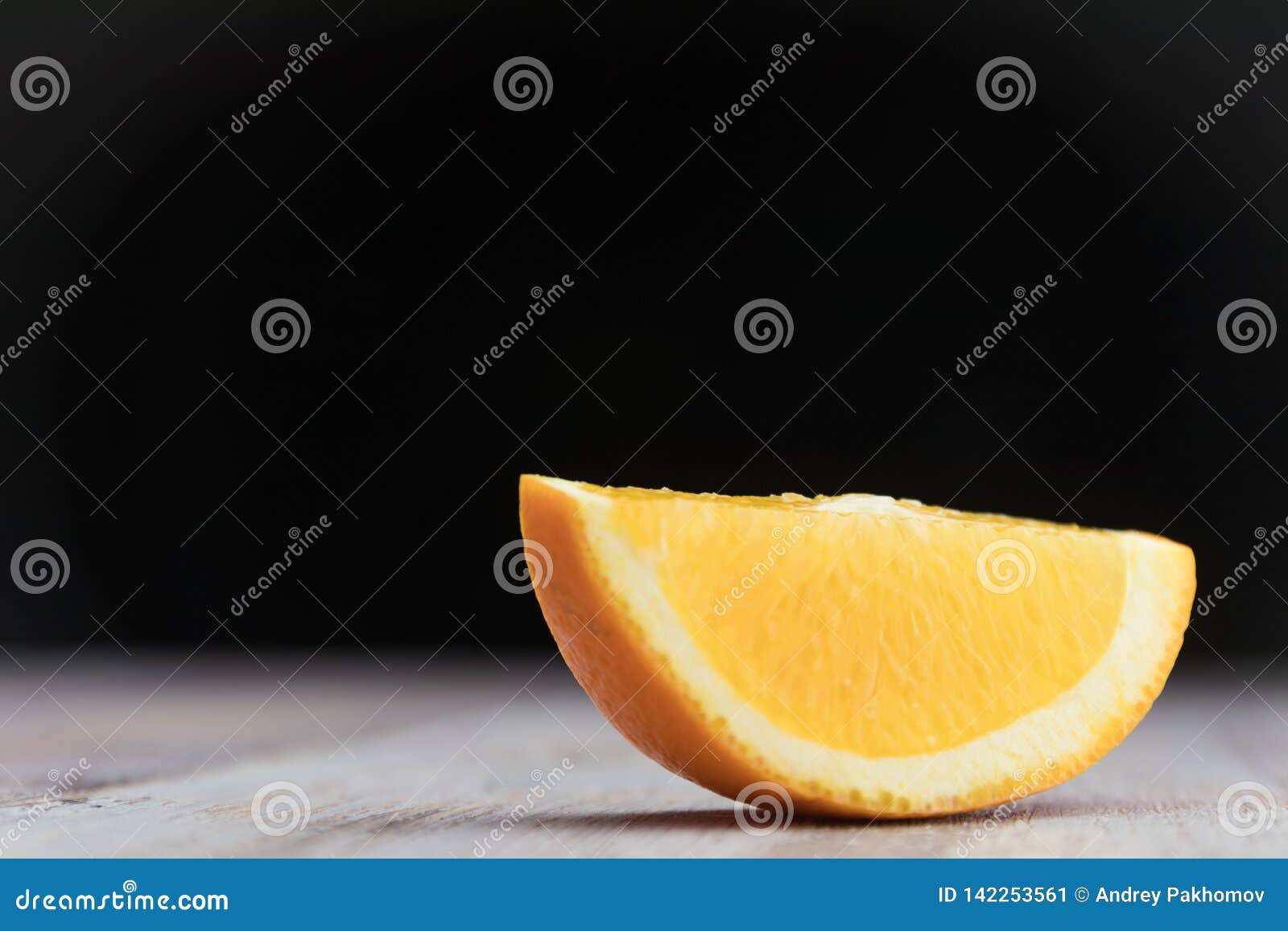 Orange Slice on Wooden Table. Orange Close-up in the Cut. Black ...