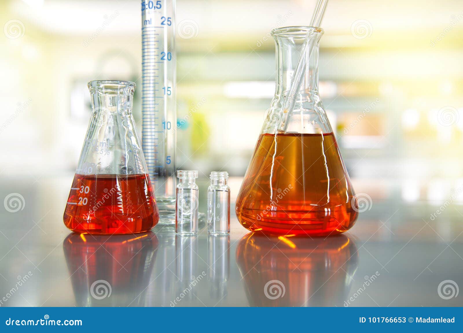 Orange Solution in Flask Cylinder Vial in Science Laboratory Background ...