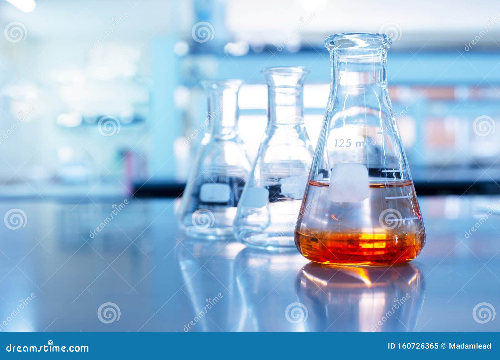 Orange Solution in Science Glass Flask in Blue Chemistry School ...