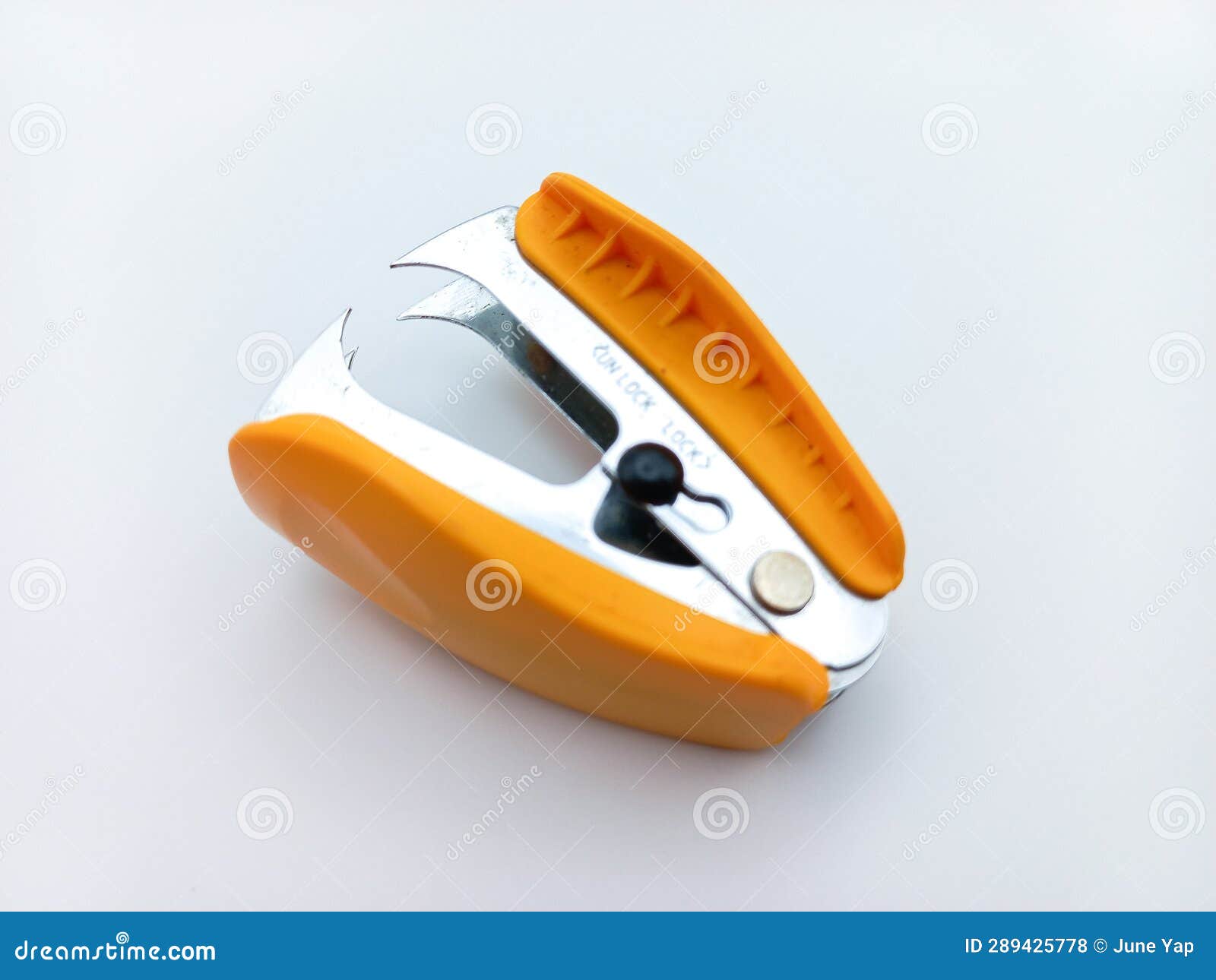 Orange Staple Remover Isolated on White Background. Tilted View from ...