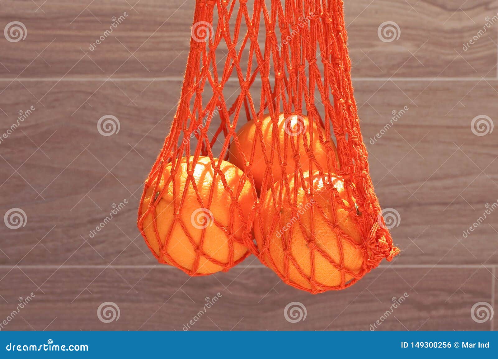 Orange string bag stock photo. Image of holding, nutrition - 149300256
