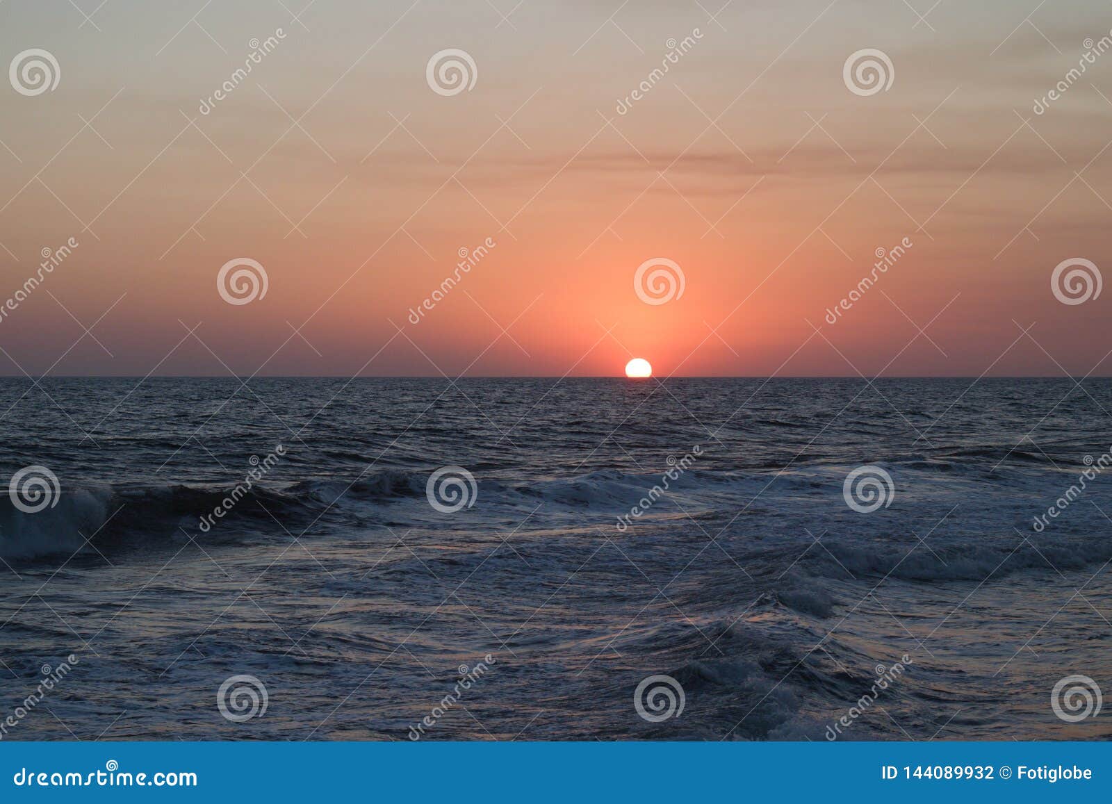 Orange Sun Halfway into the Ocean Stock Photo - Image of morning, water ...