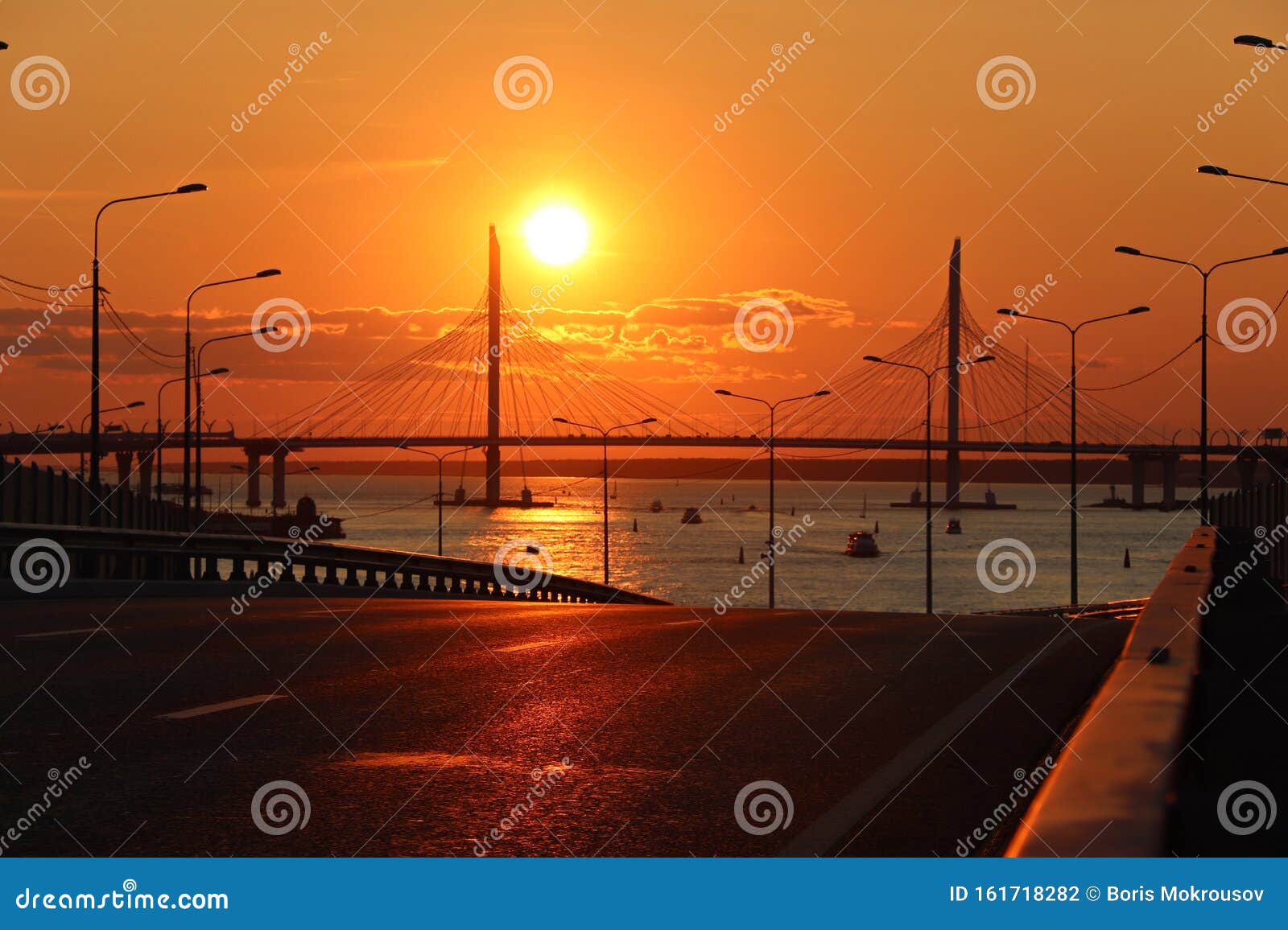 Orange Sunset Over the Highway with a Bridge Over the River and Stock ...