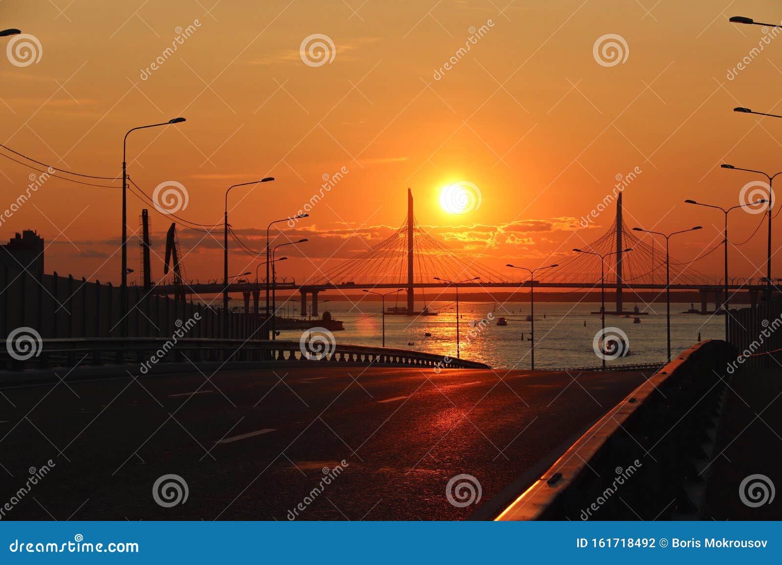 Orange Sunset Over the Highway with a Bridge Over the River and Stock ...