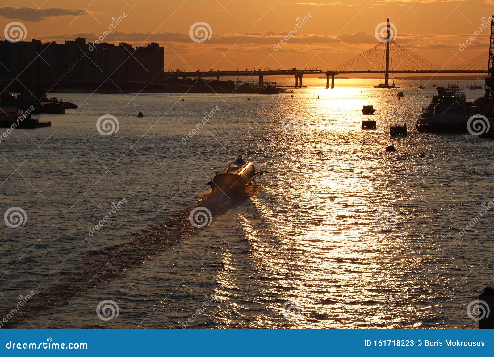 Orange Sunset Over the River with a Bridge and Boats Stock Image ...