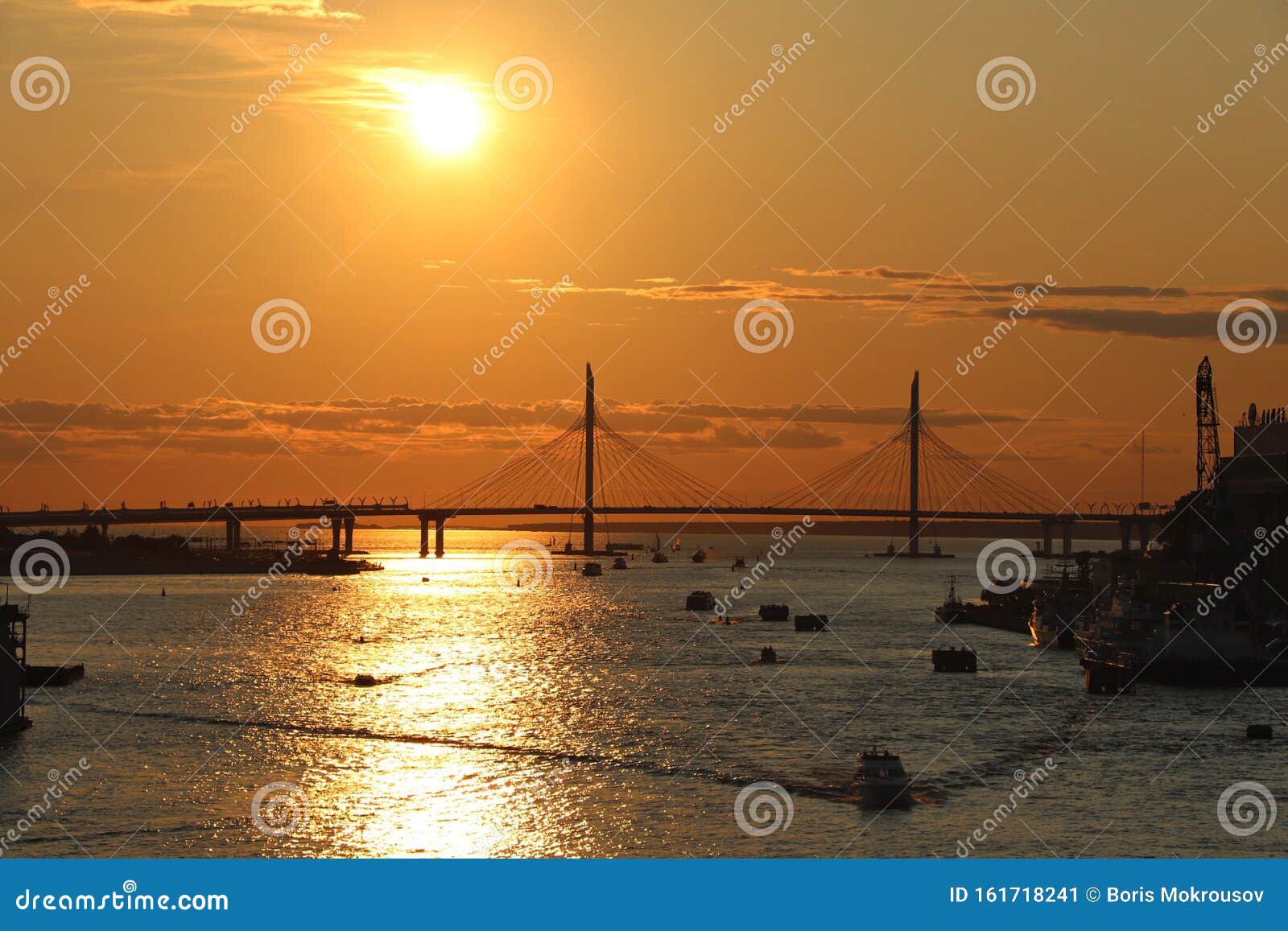 Orange Sunset Over the River with a Bridge and Boats Stock Image ...