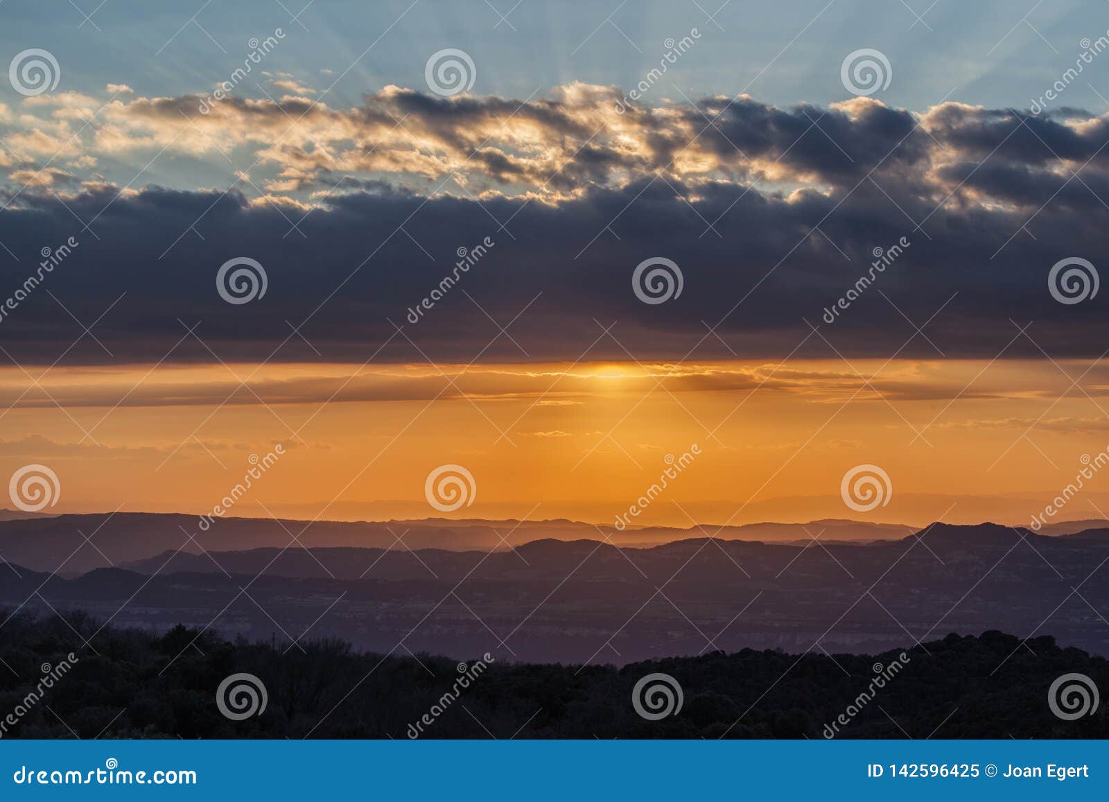 Orange Sunset with Sunrays Over Dark Cloudscape Stock Image - Image of ...