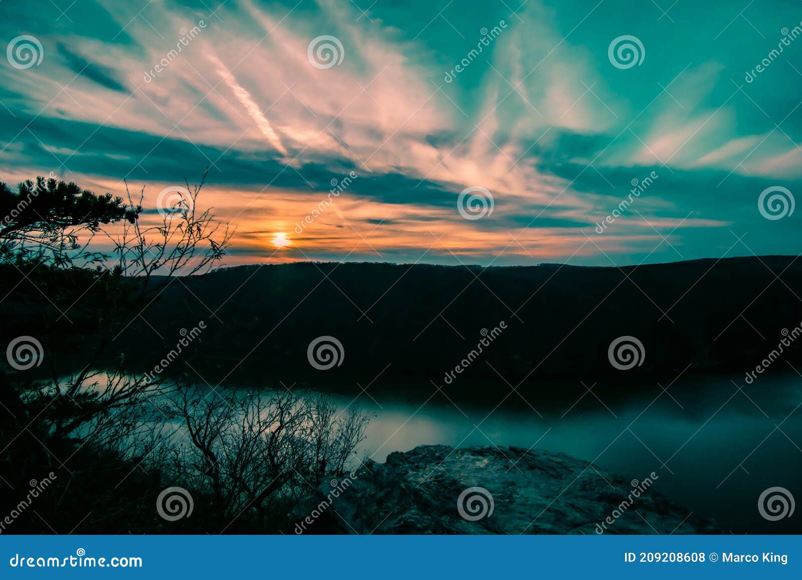 Orange and Teal Sunset Over a Lake and Mountain Stock Photo - Image of ...