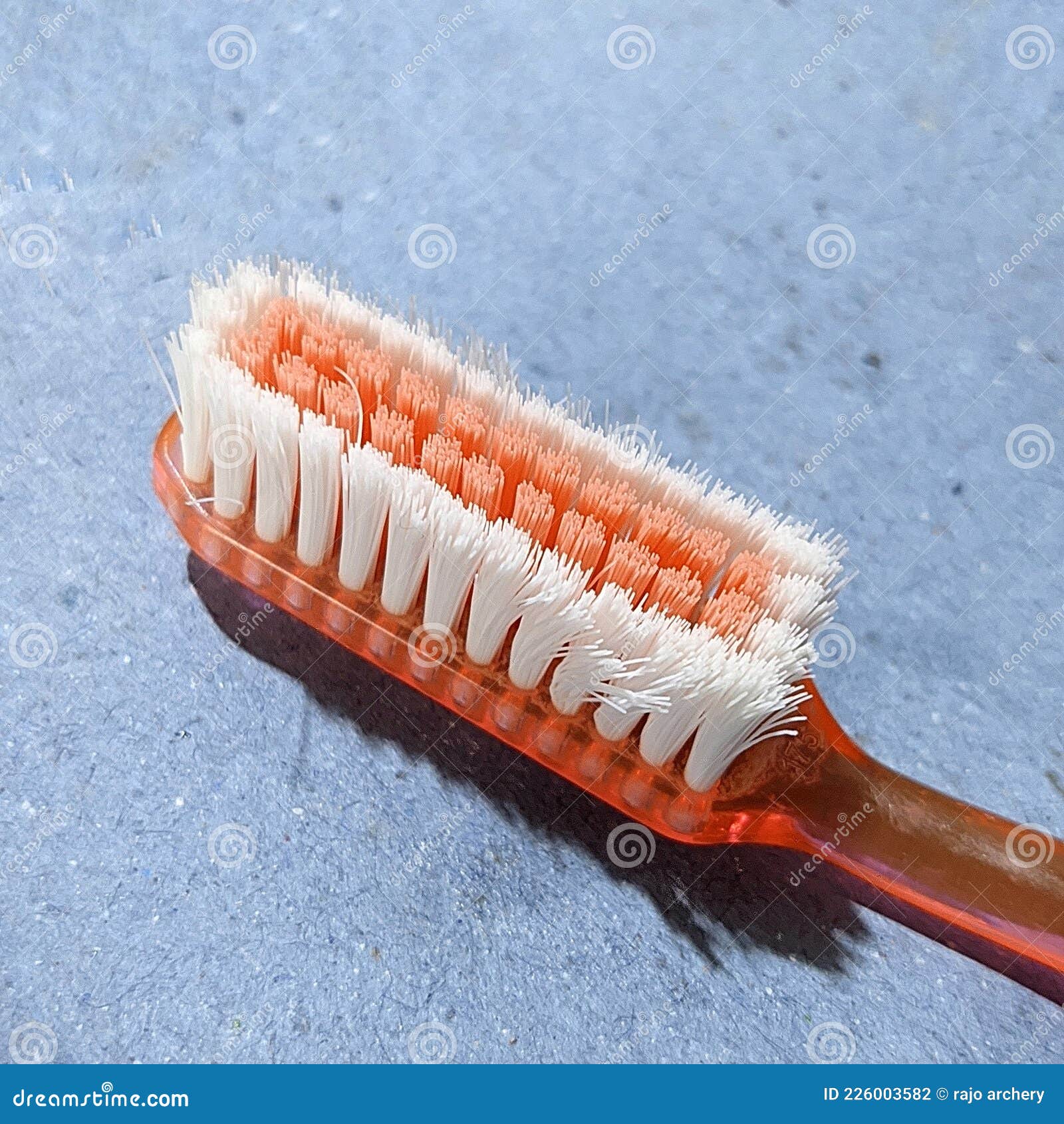 An Orange Toothbrush on a Blue Background Stock Photo - Image of ...