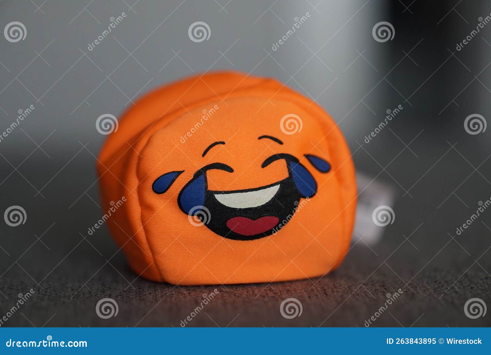 Orange Toy with a Laughing Emoji Face Stock Image - Image of orange ...