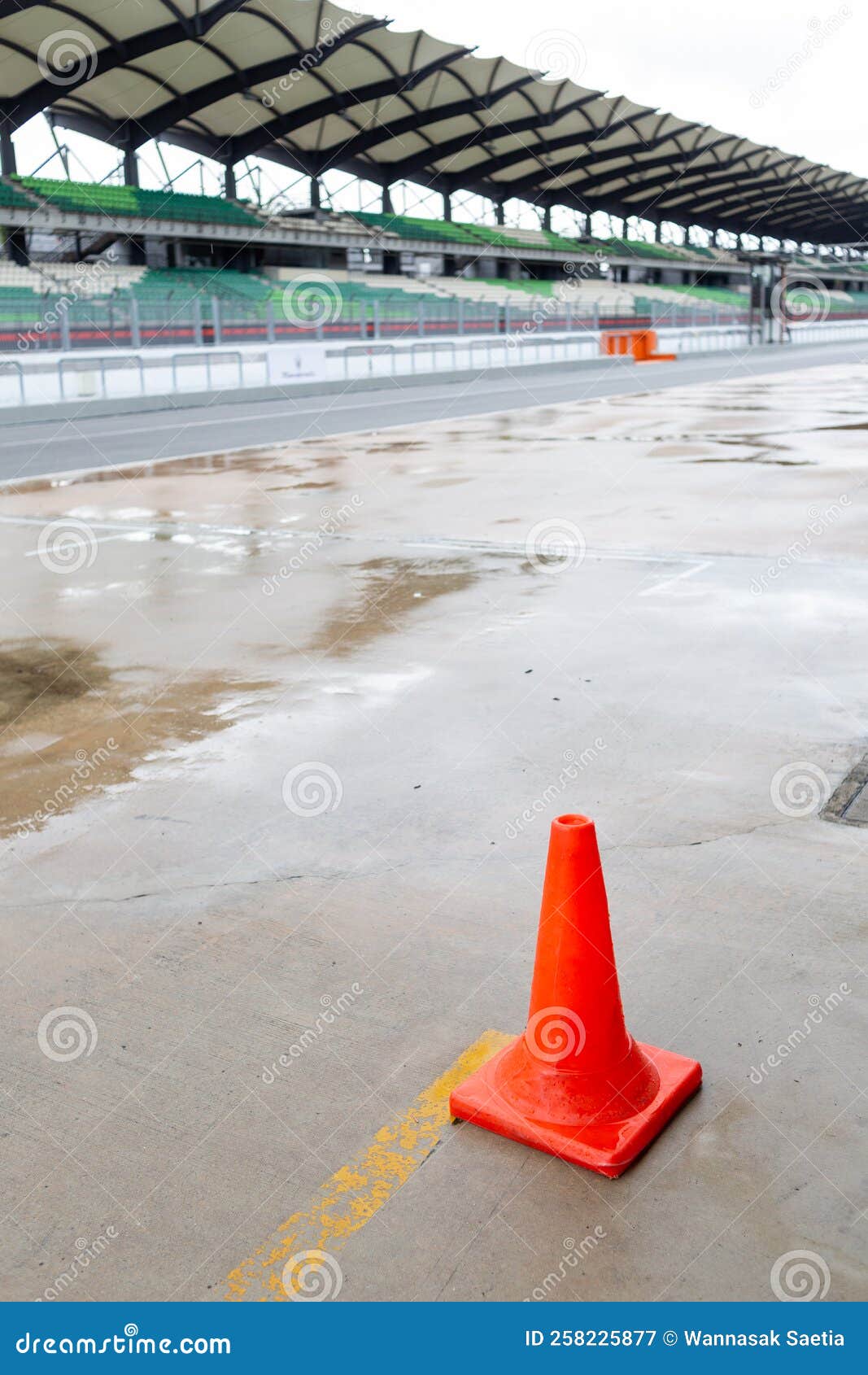 An Orange Traffic Cone is Placed on the Edge of the Racetrack Stock ...