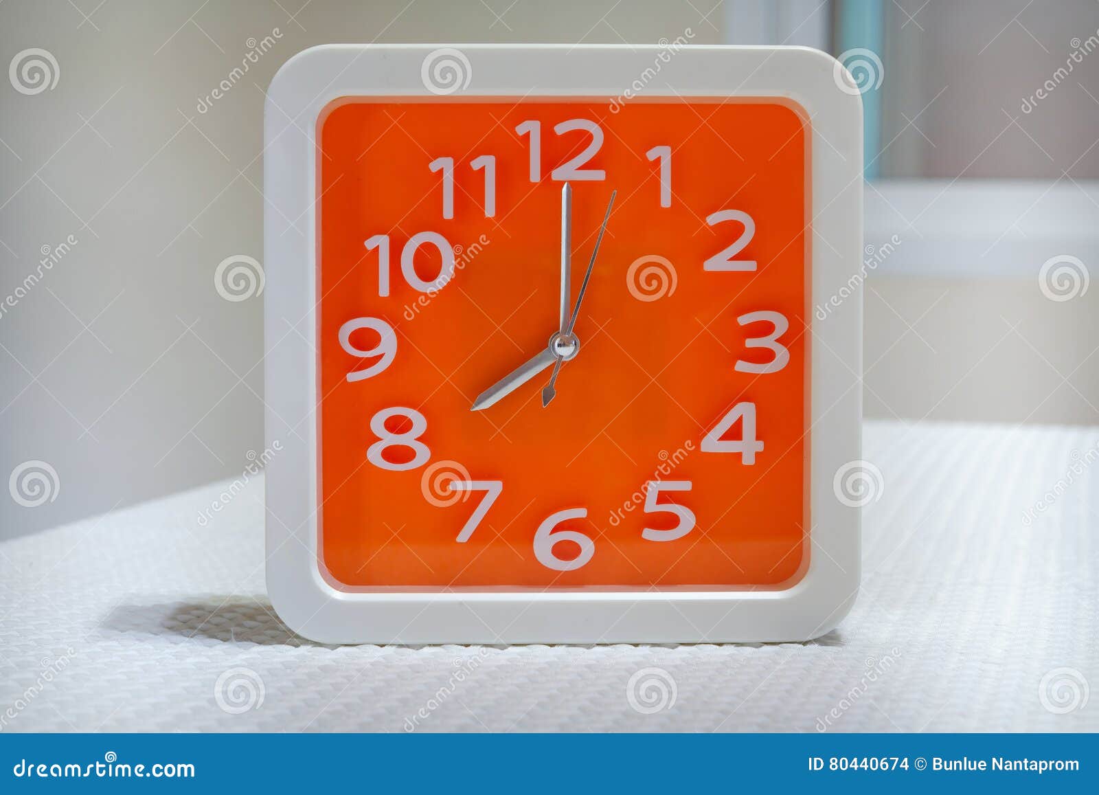 Orange Wall Clock on White Table Stock Photo - Image of modern, orange ...
