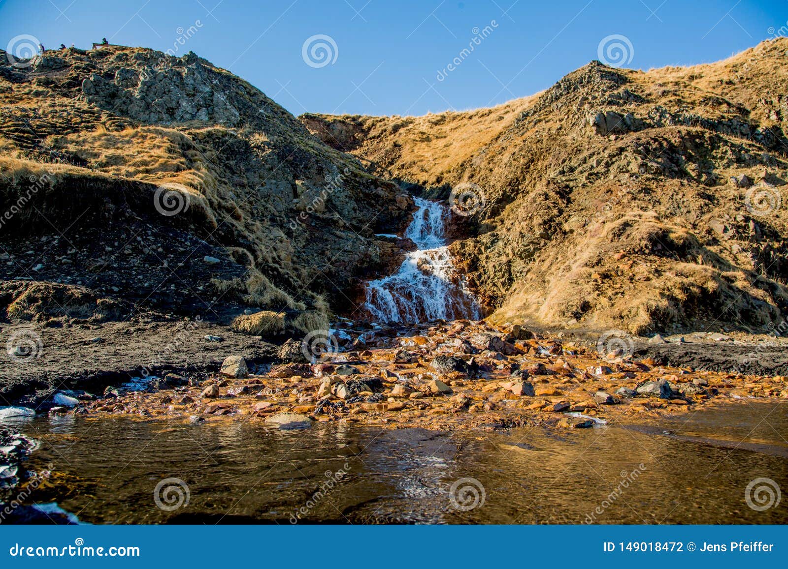 Orange Waterfall from Below, Framed by Rock Stock Photo - Image of ...