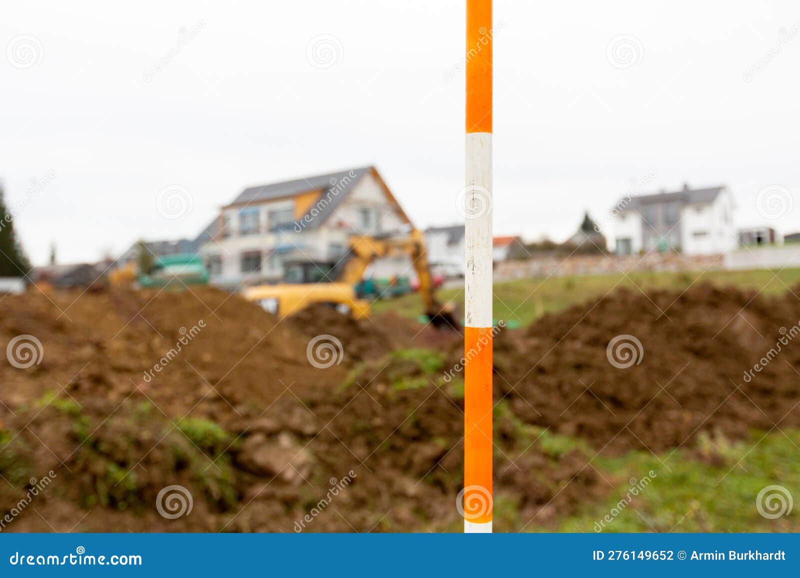 Orange and White Boning Rod for Surveying in the Foreground of a ...