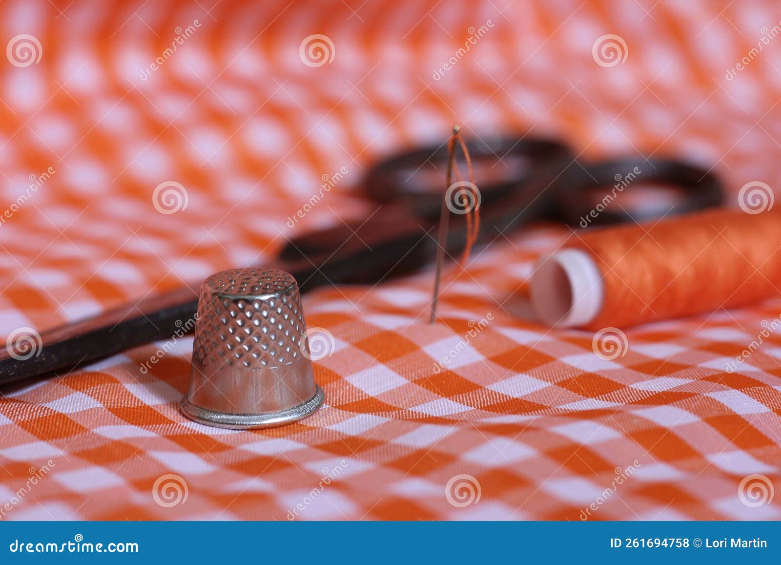 Orange and White Checkered Fabric with Thimble and Spool of Orange ...