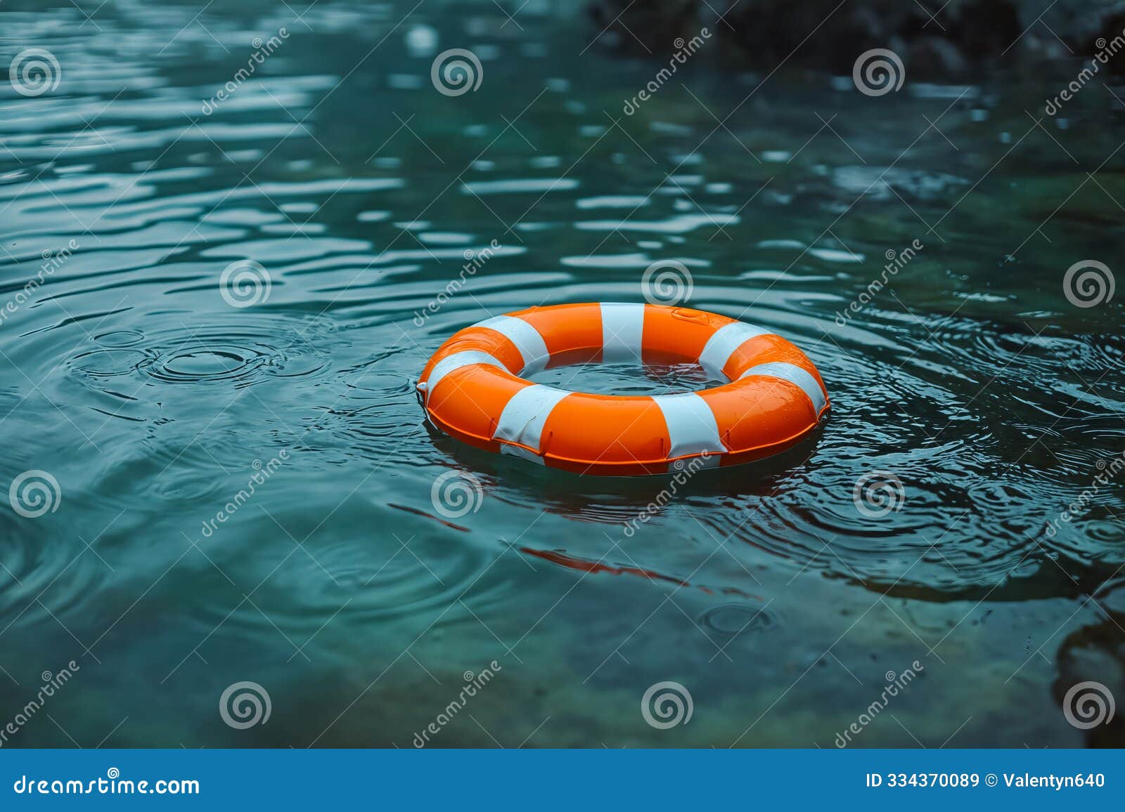 An Orange and White Life Preserver Floating in the Water Stock Image ...