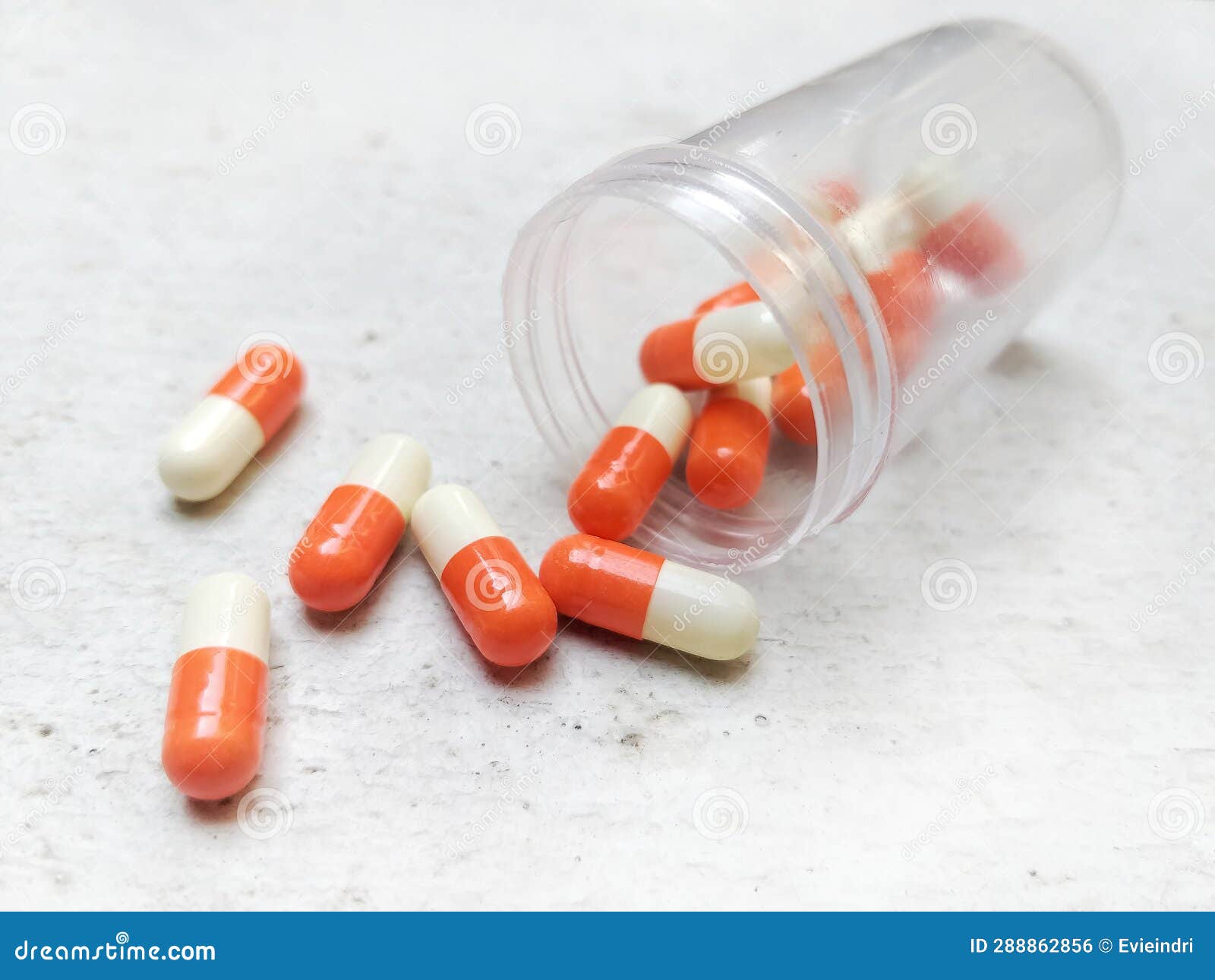Orange White Medicine Capsules Falling from Capsule Bottle with ...