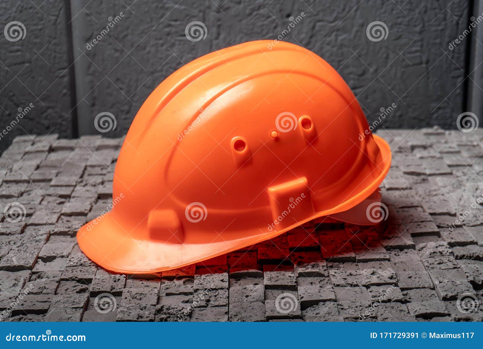 Orange Workers Helmet On Grey Wall Background. Architectural Work Place ...