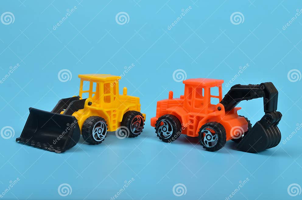 An Orange and Yellow Backhoe Loader Isolated on a Blue Background Stock ...